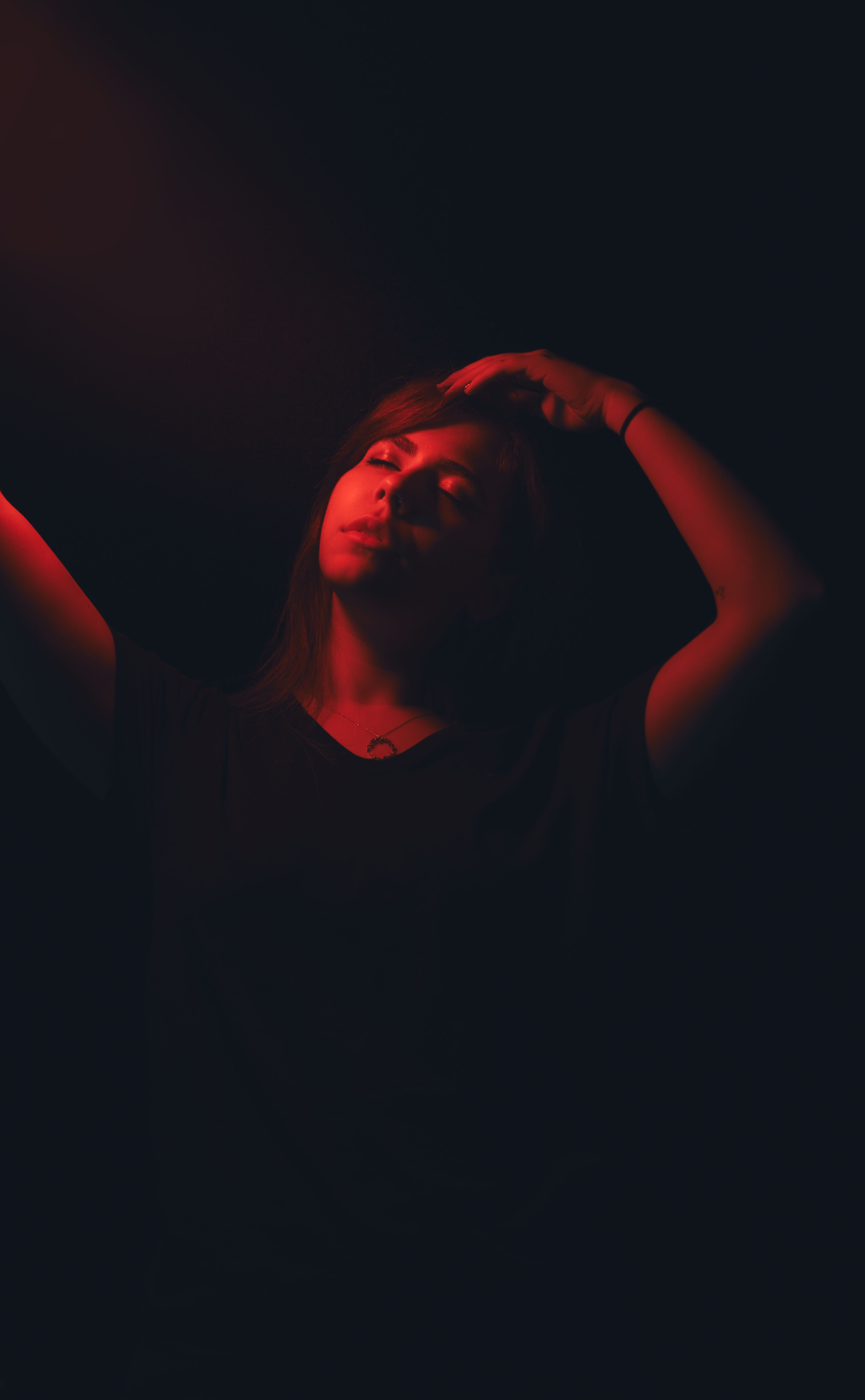 Moody Portrait of a Woman in Red Light · Free Stock Photo