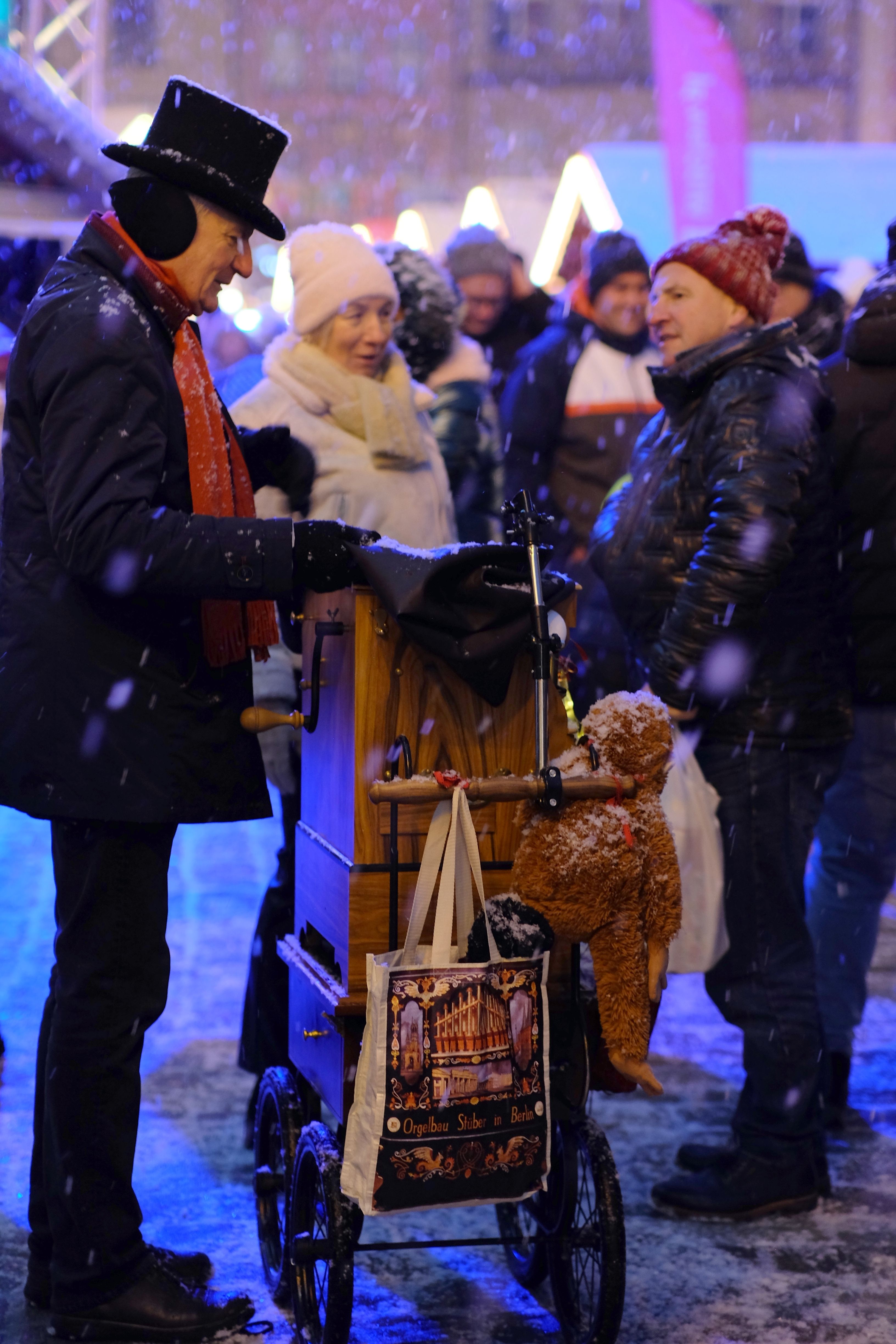 Festive Street Musician Entertains Winter Crowd · Free Stock Photo