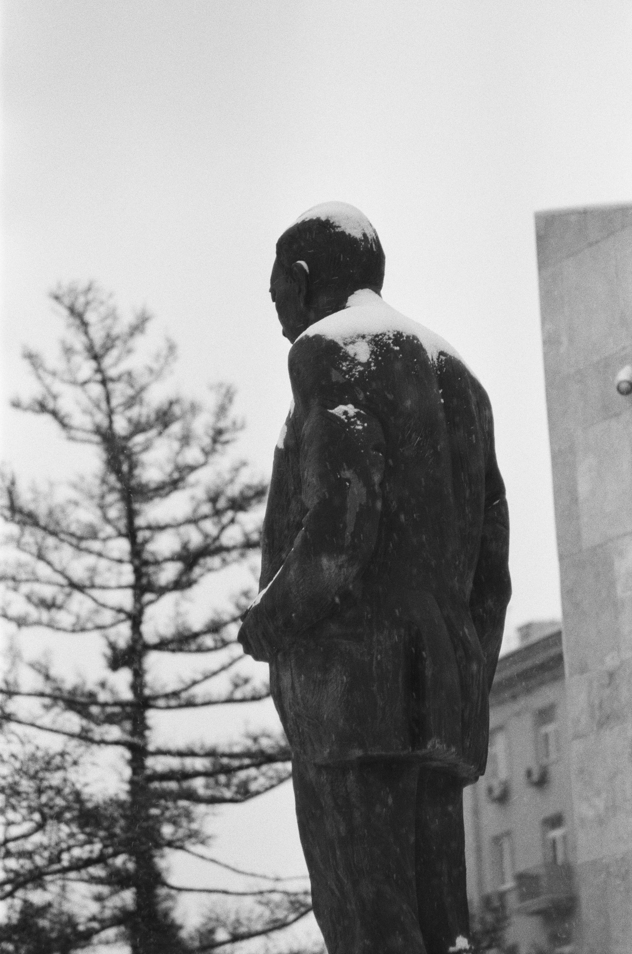 Snow-Covered Statue in Urban Winter Scene · Free Stock Photo