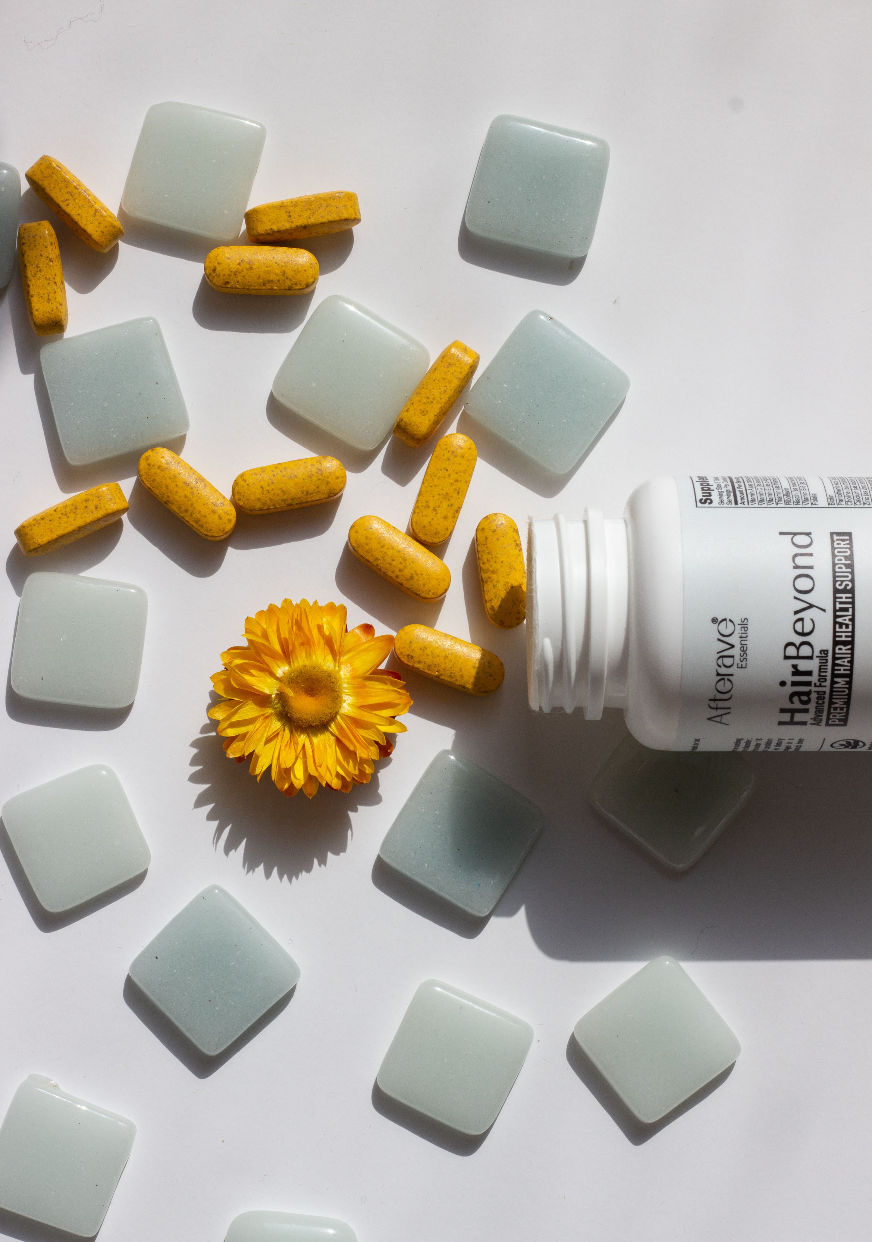 Flat Lay of Hair Growth Vitamins with Flower · Free Stock Photo