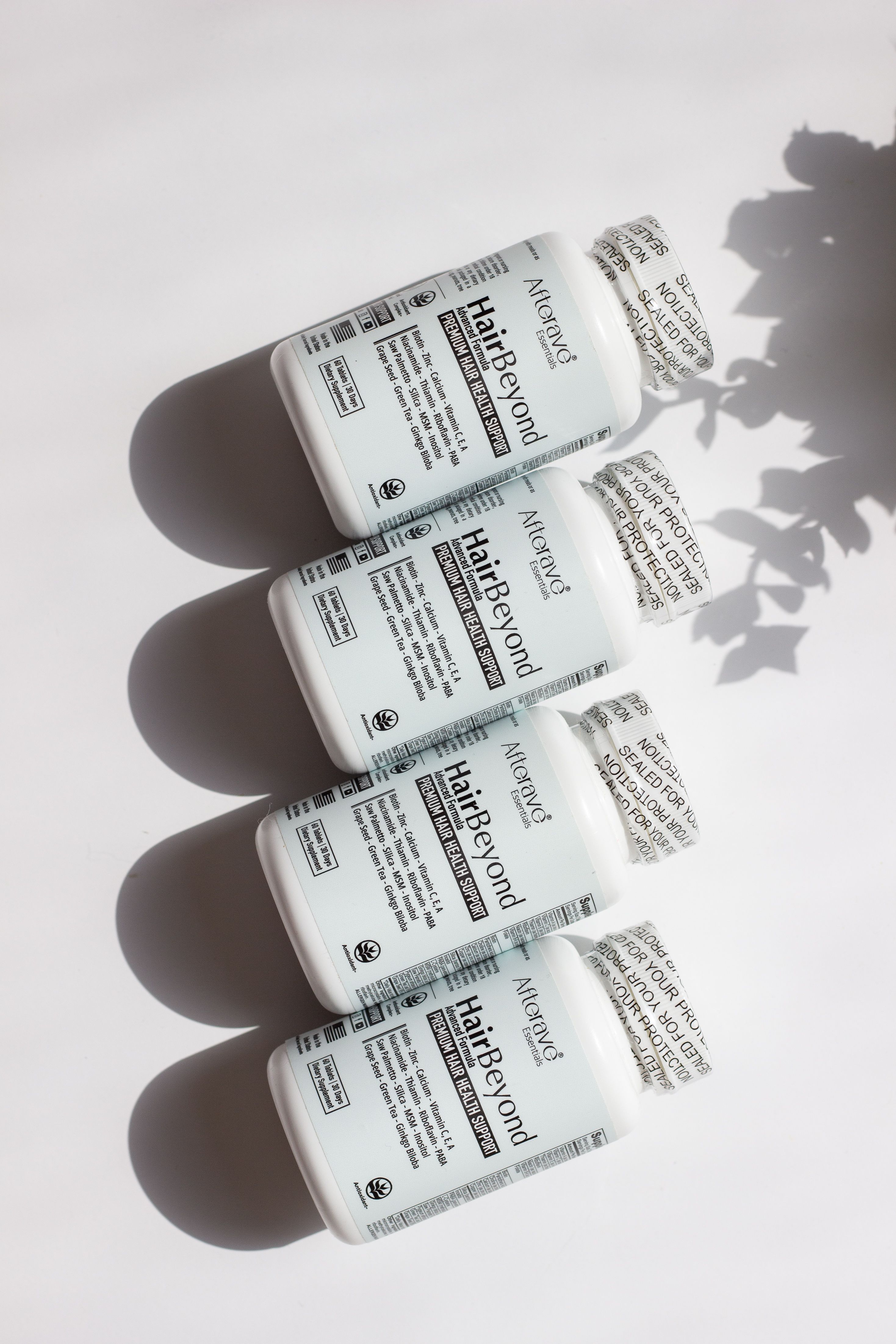 Bottles of Hair Growth Vitamins in Bright Light · Free Stock Photo