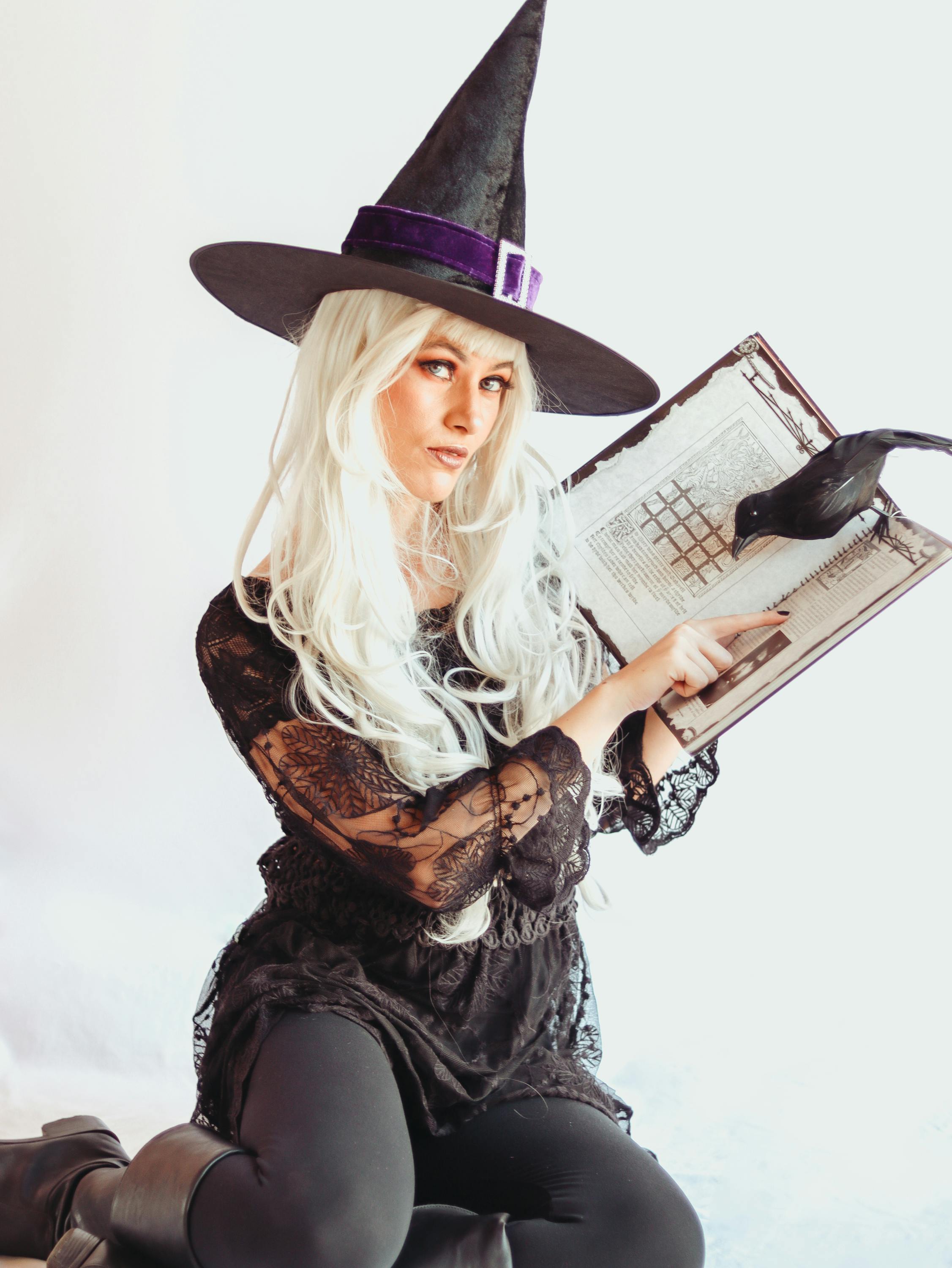 Enchanting Witch with Spellbook and Raven · Free Stock Photo