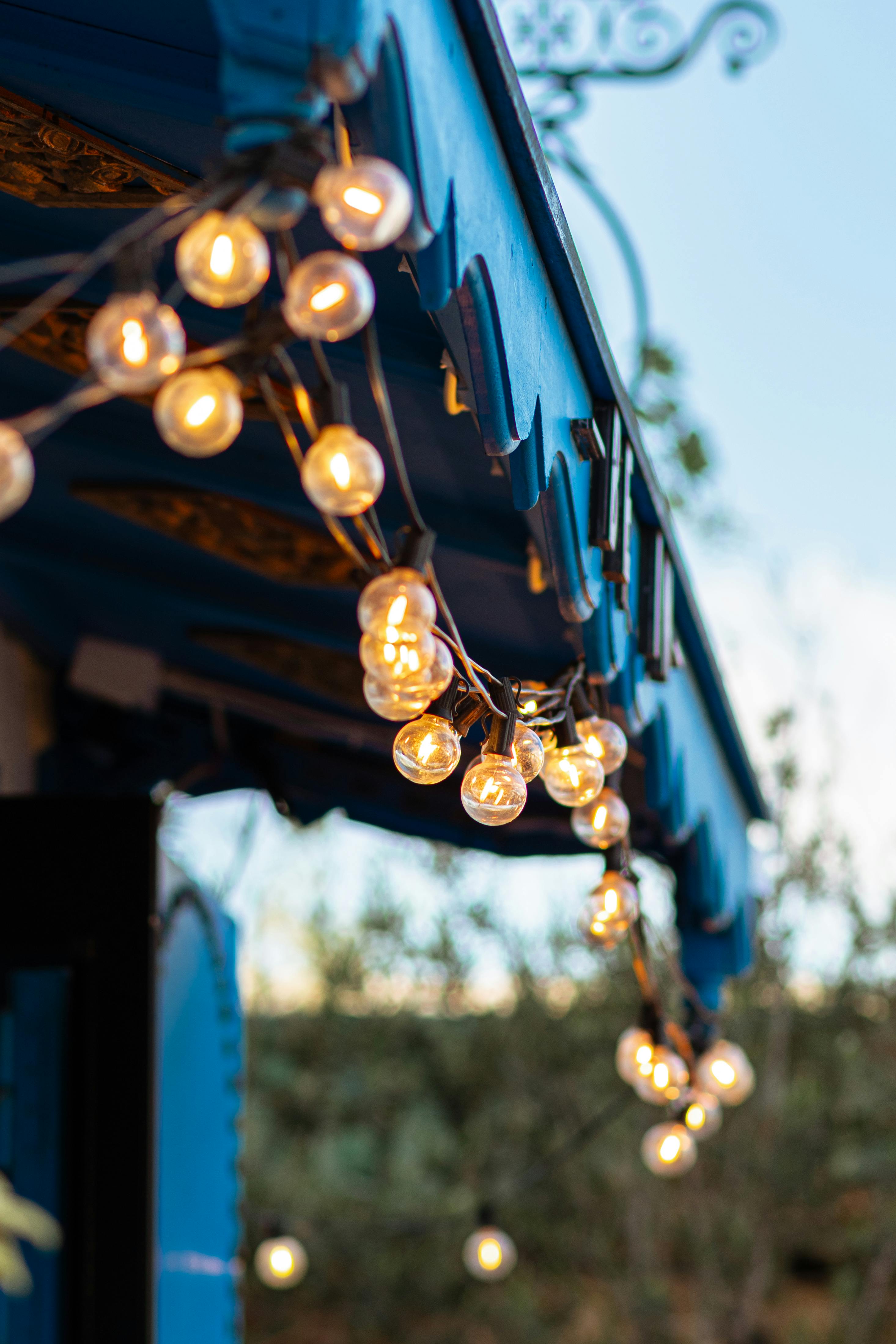 Festive String Lights on Blue Awning Outdoors · Free Stock Photo