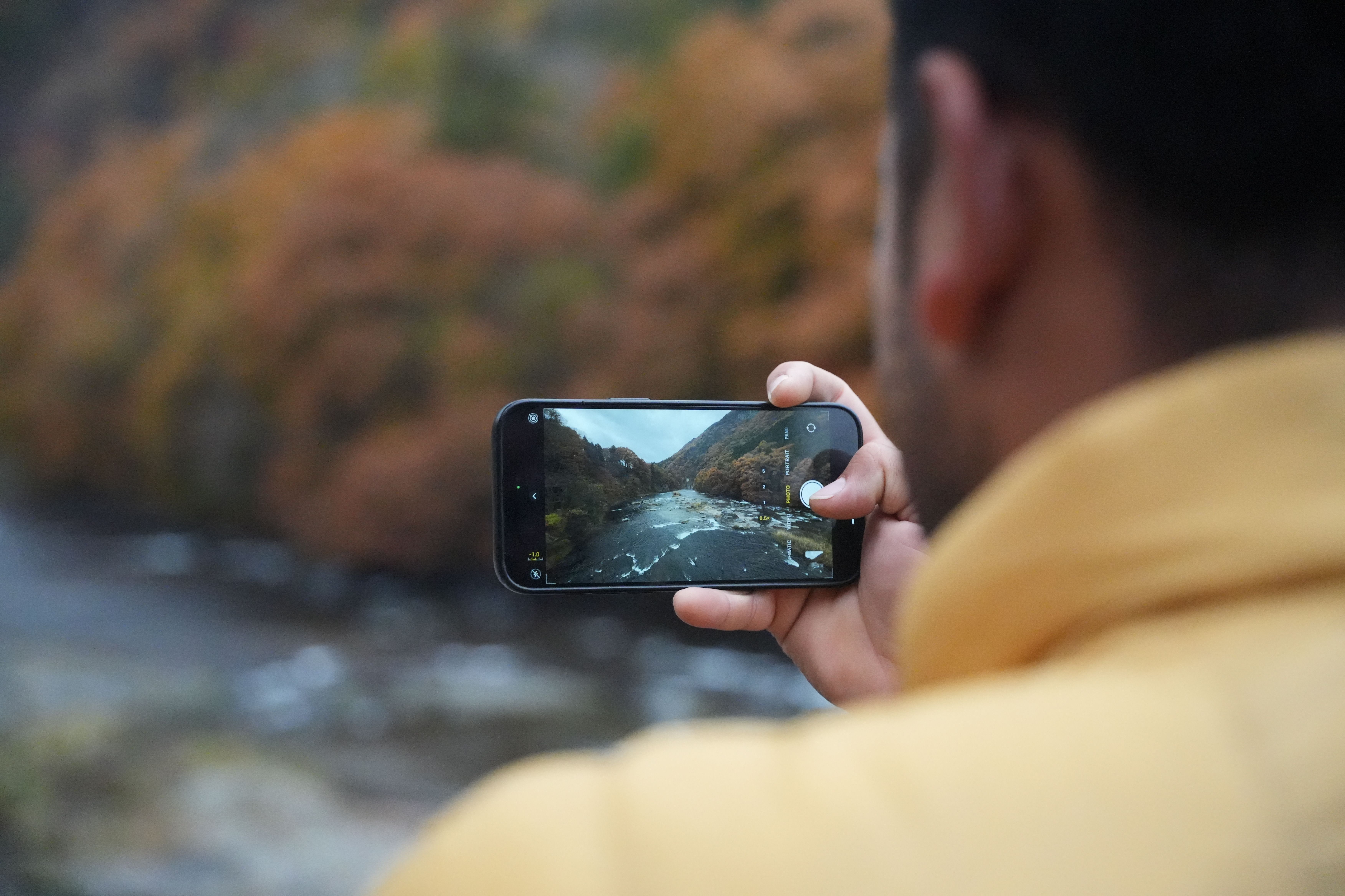Capturing Autumn Landscape with Smartphone · Free Stock Photo