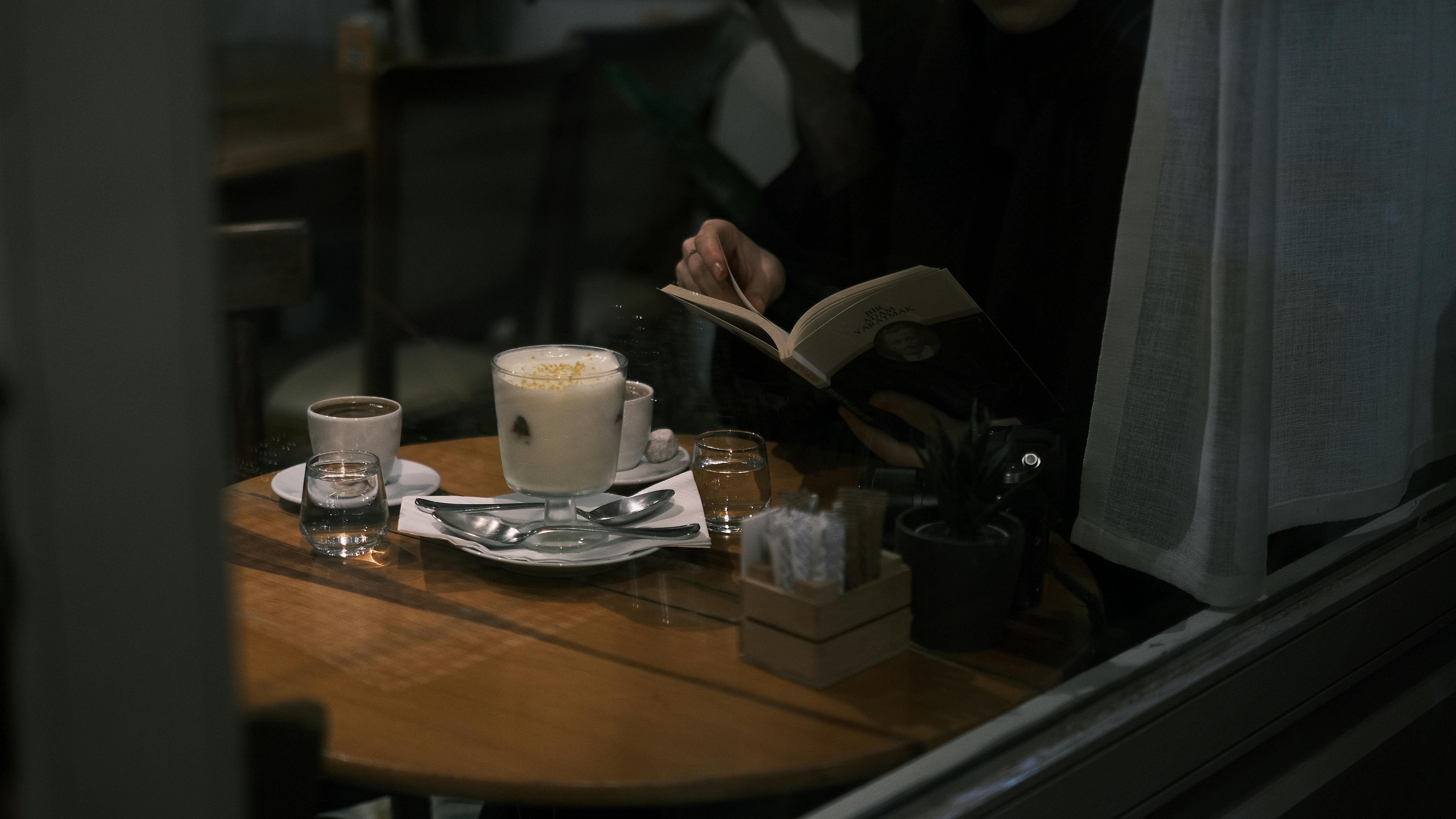 Cozy Cafe Reading with Coffee at Night · Free Stock Photo