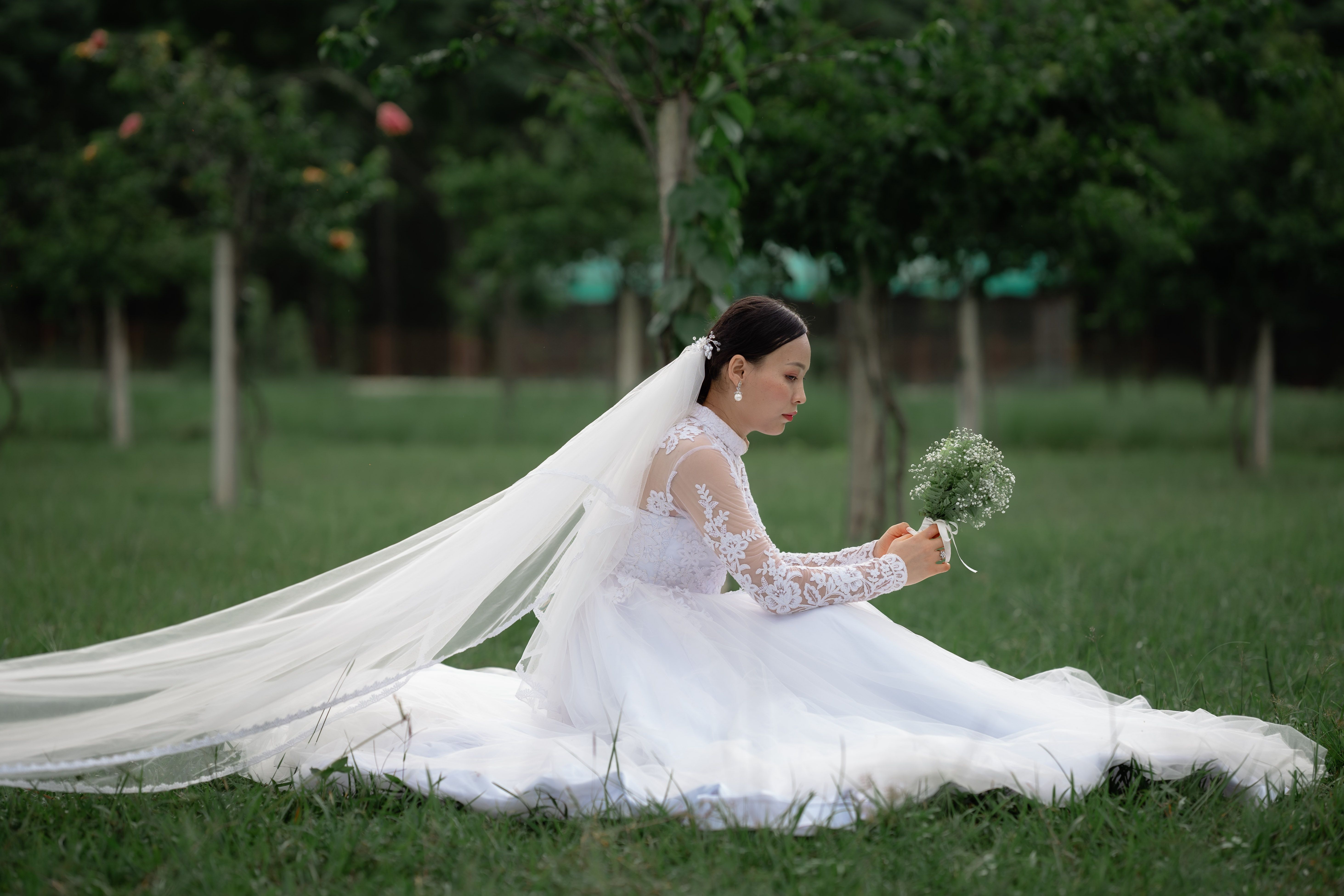 Bride Sitting in Garden in White Wedding Dress · Free Stock Photo