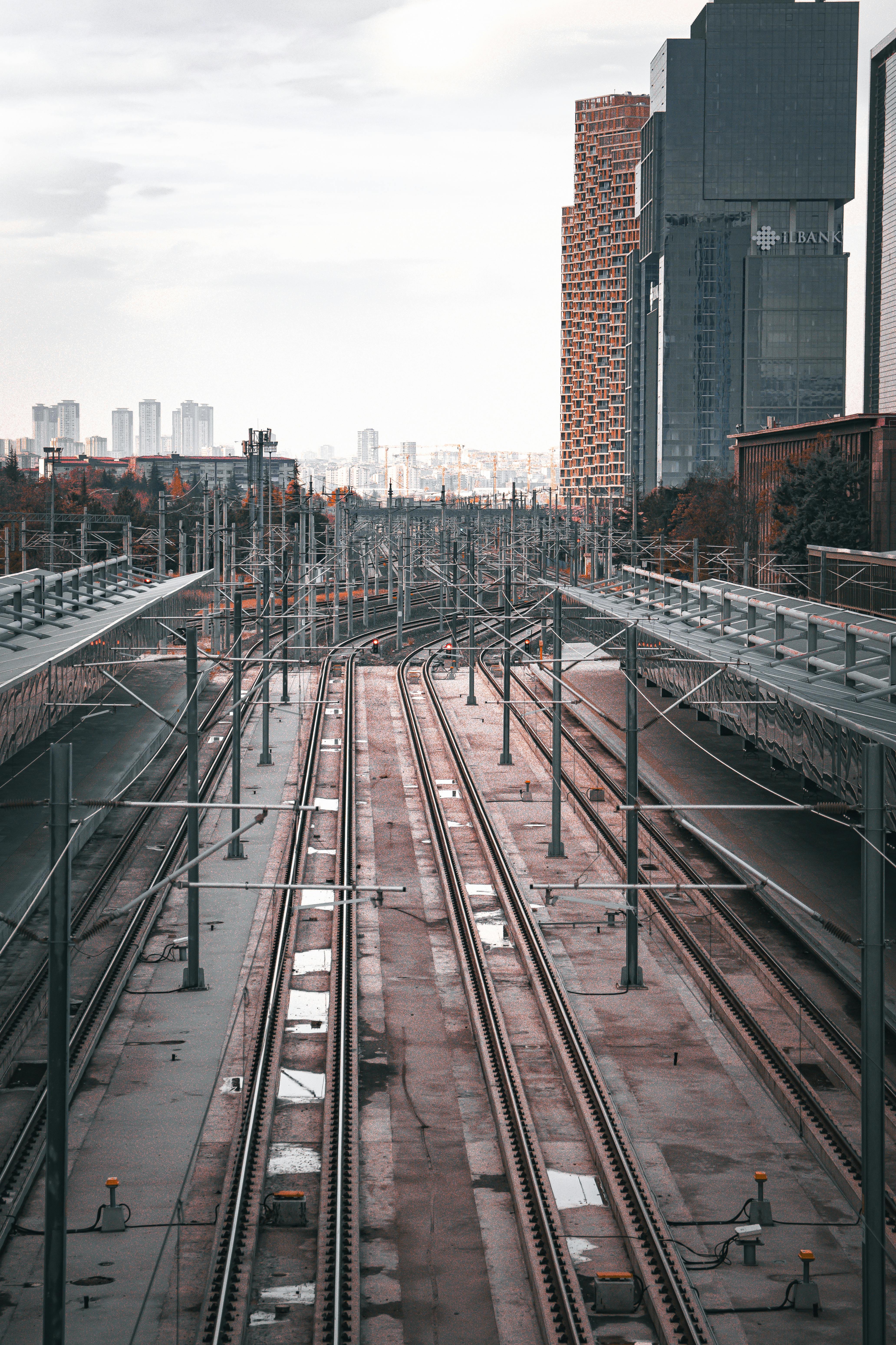 Urban Railway Tracks Leading into Cityscape · Free Stock Photo