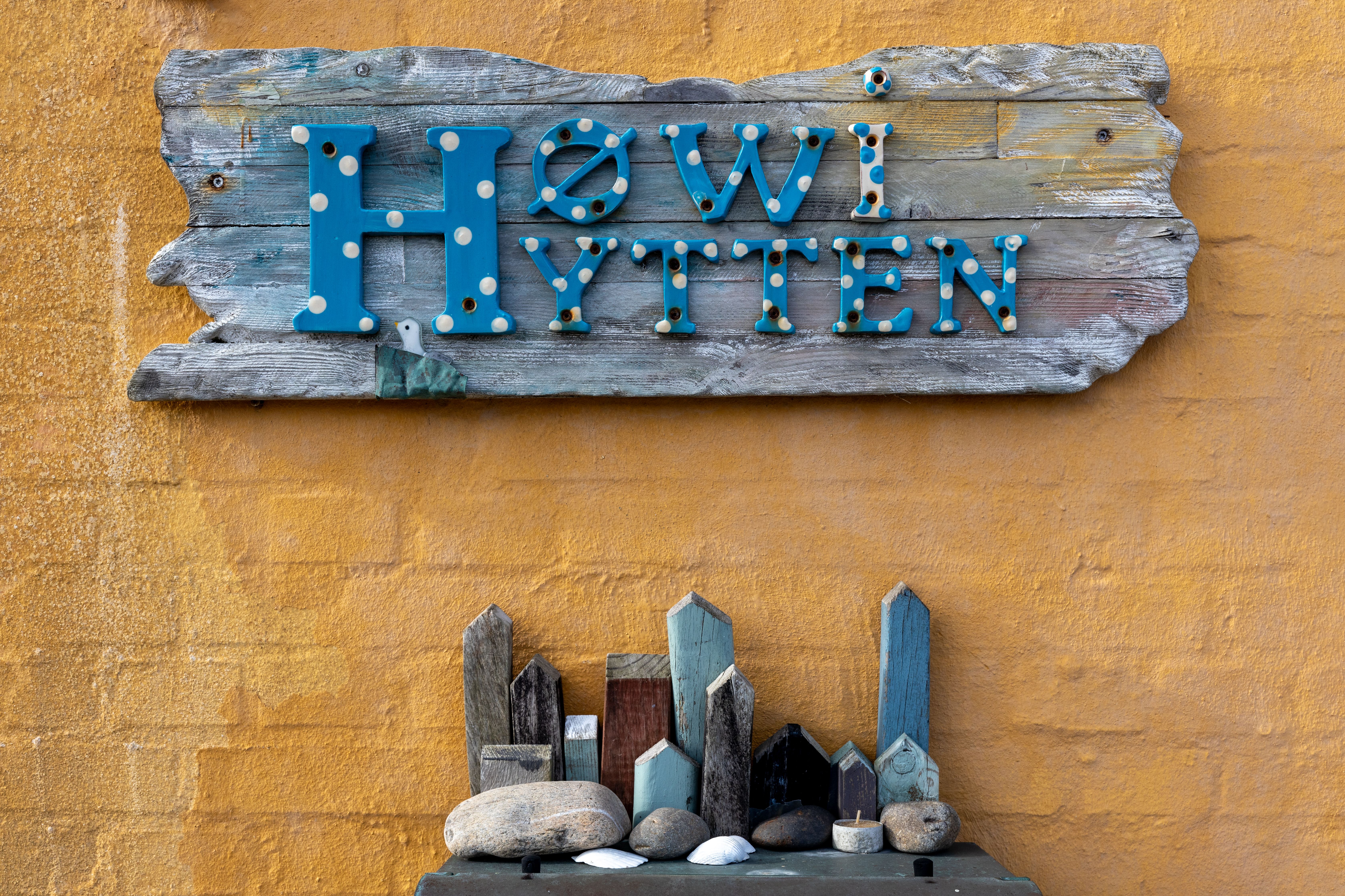 Rustic Wooden Sign on Textured Wall · Free Stock Photo