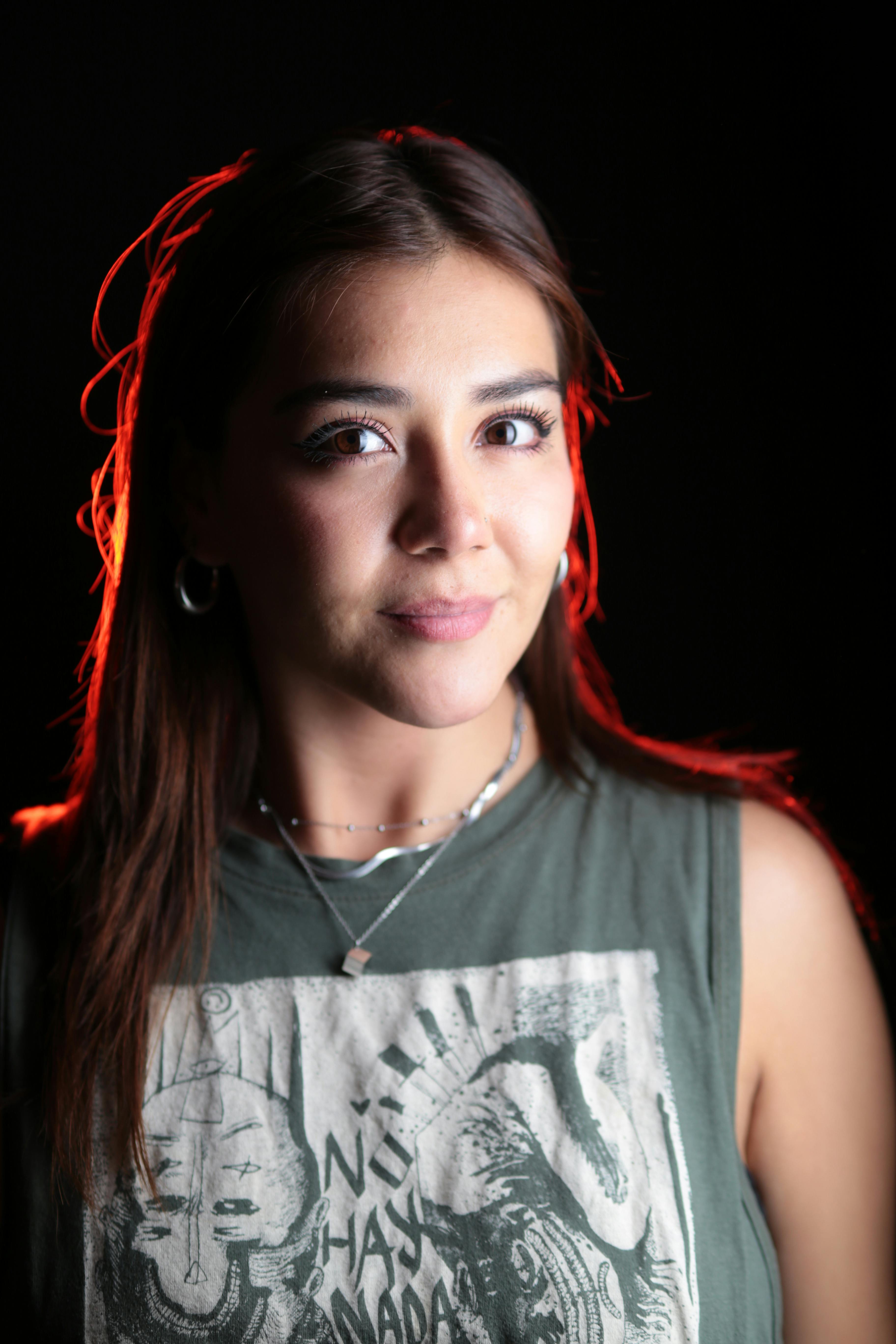 Portrait of a Woman with Red Backlighting in Studio · Free Stock Photo