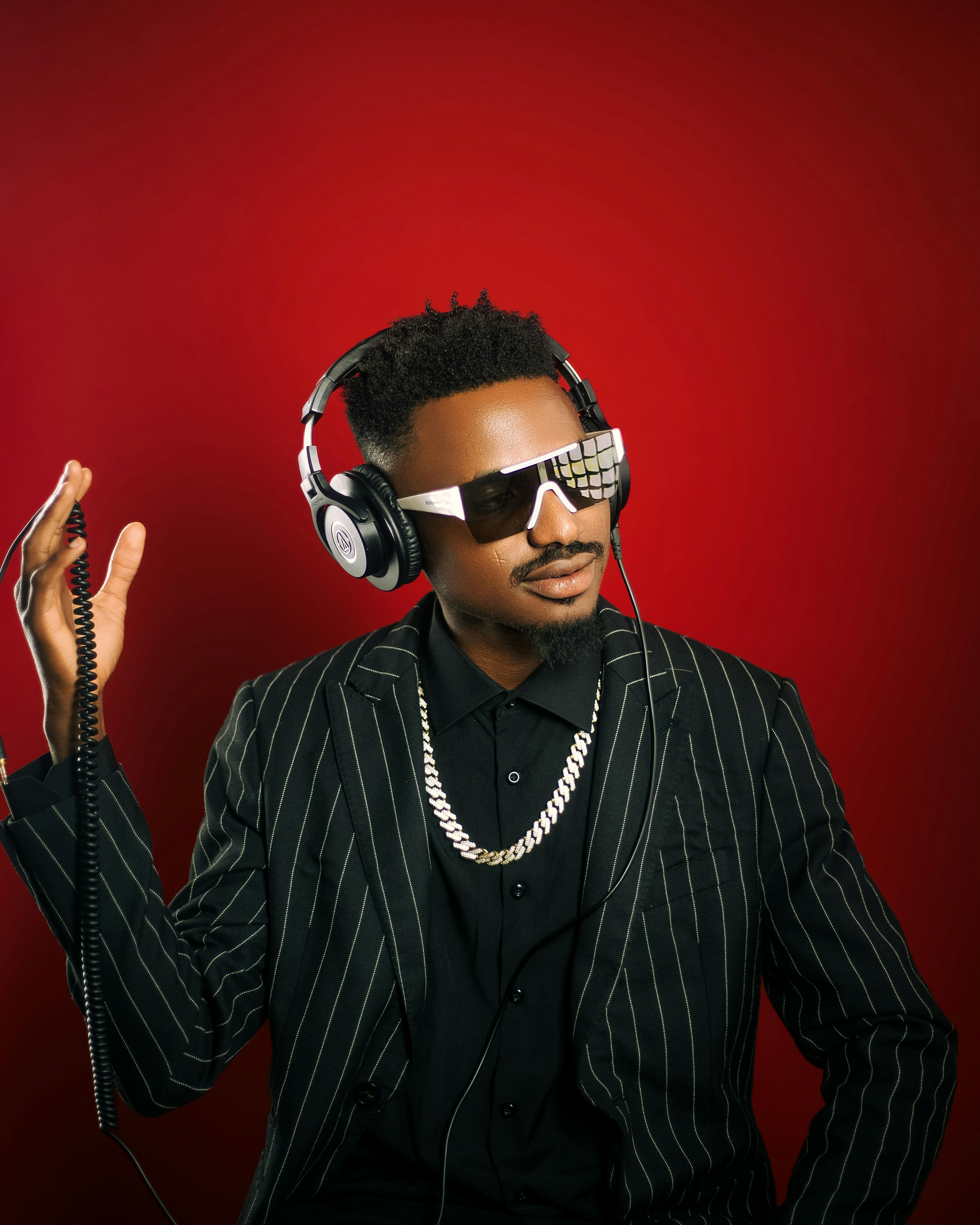 Stylish DJ in Pinstripe Suit with Headphones · Free Stock Photo