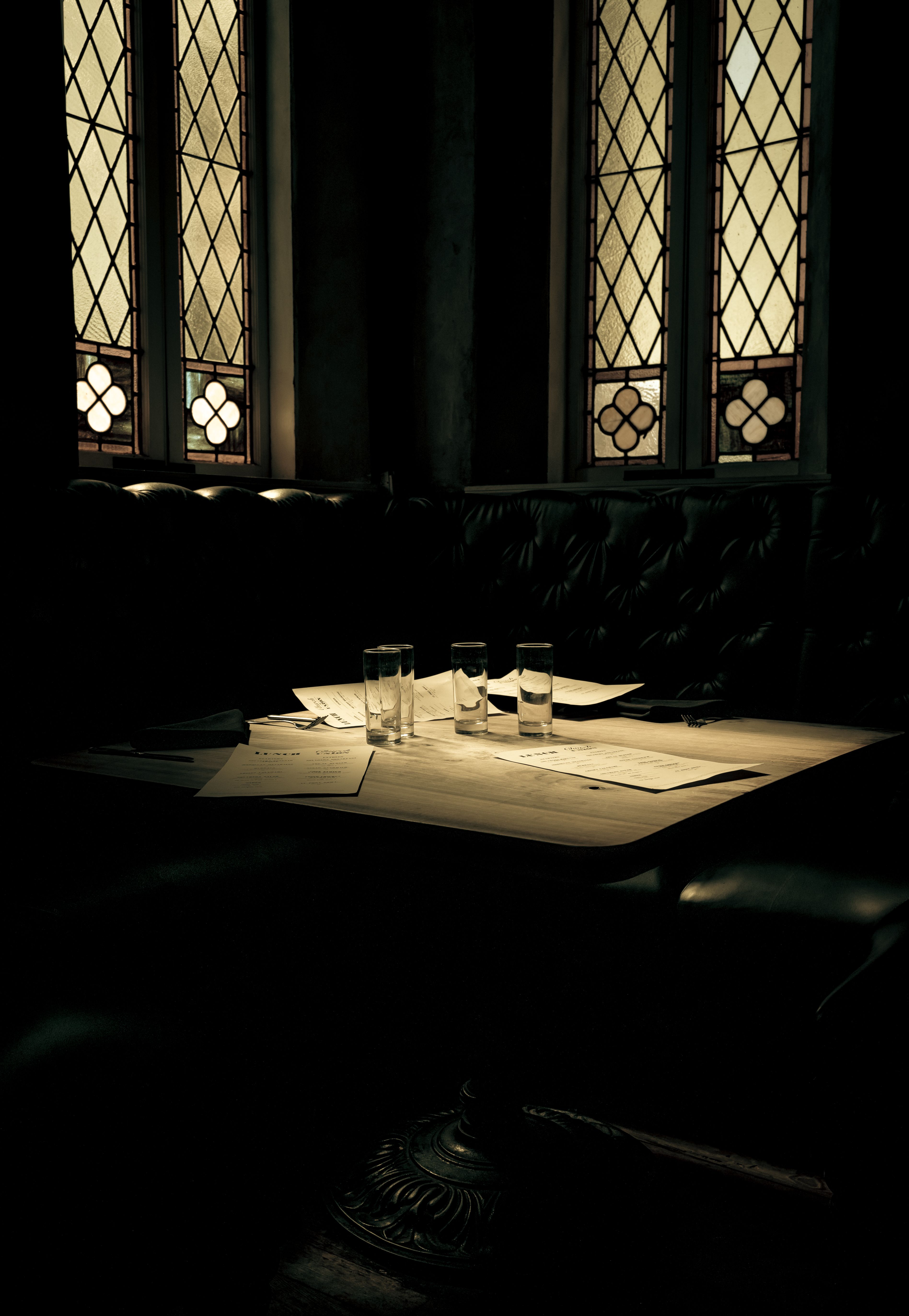 Dimly Lit Table with Stained Glass Background · Free Stock Photo