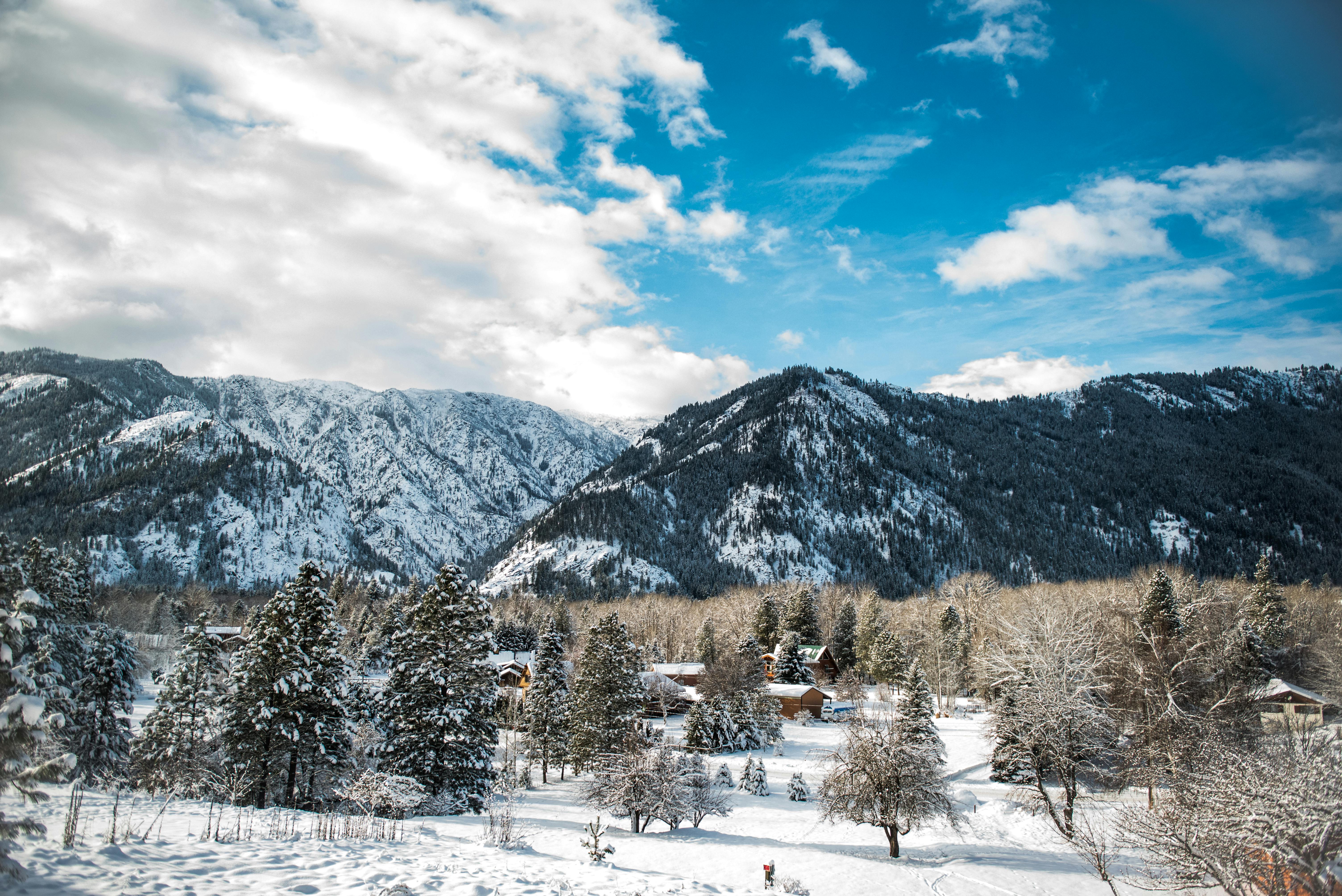 Scenic Winter Landscape with Snow-Covered Mountains · Free Stock Photo