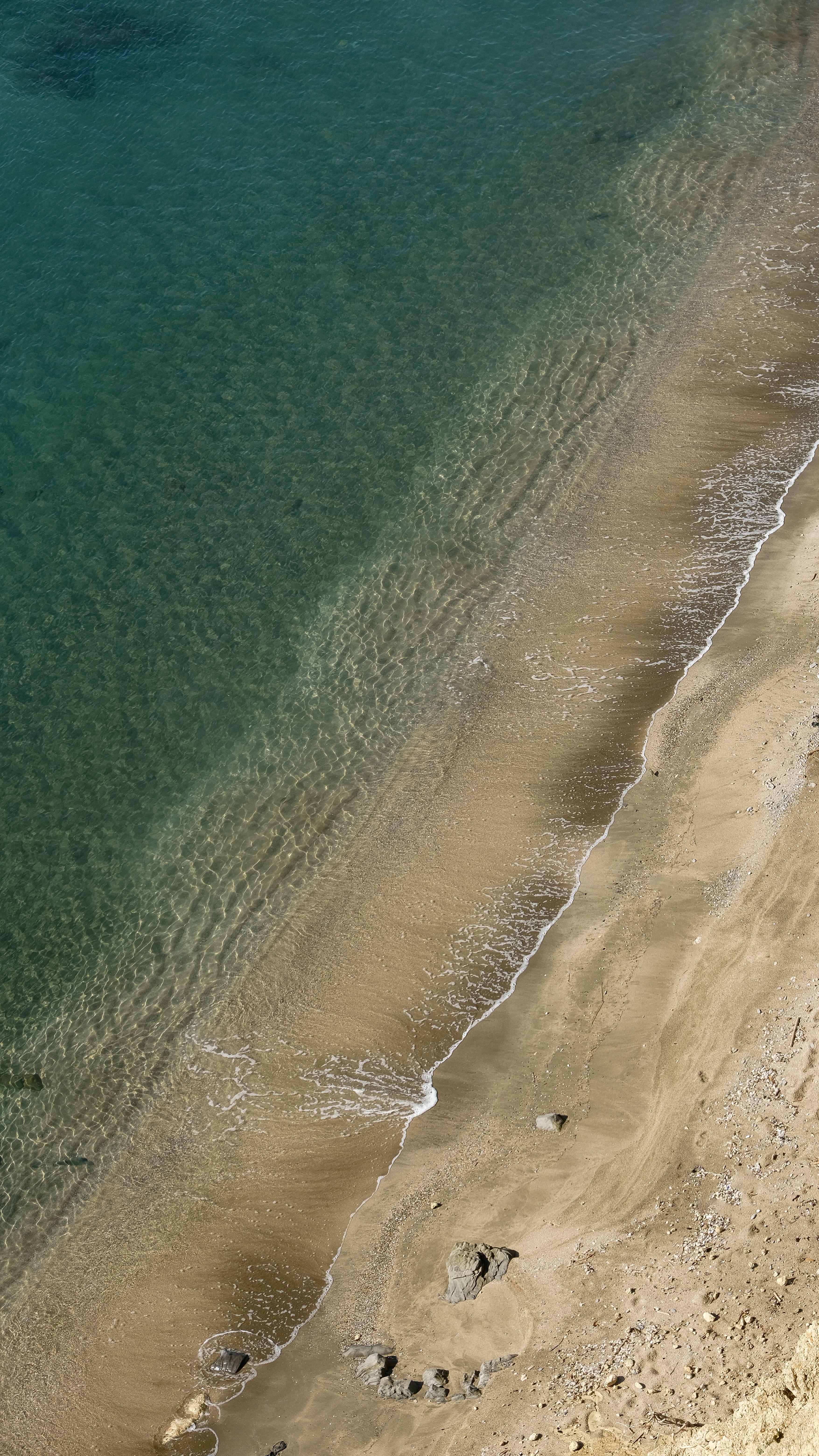 Serene Aerial View of a Sandy Beach Shoreline · Free Stock Photo