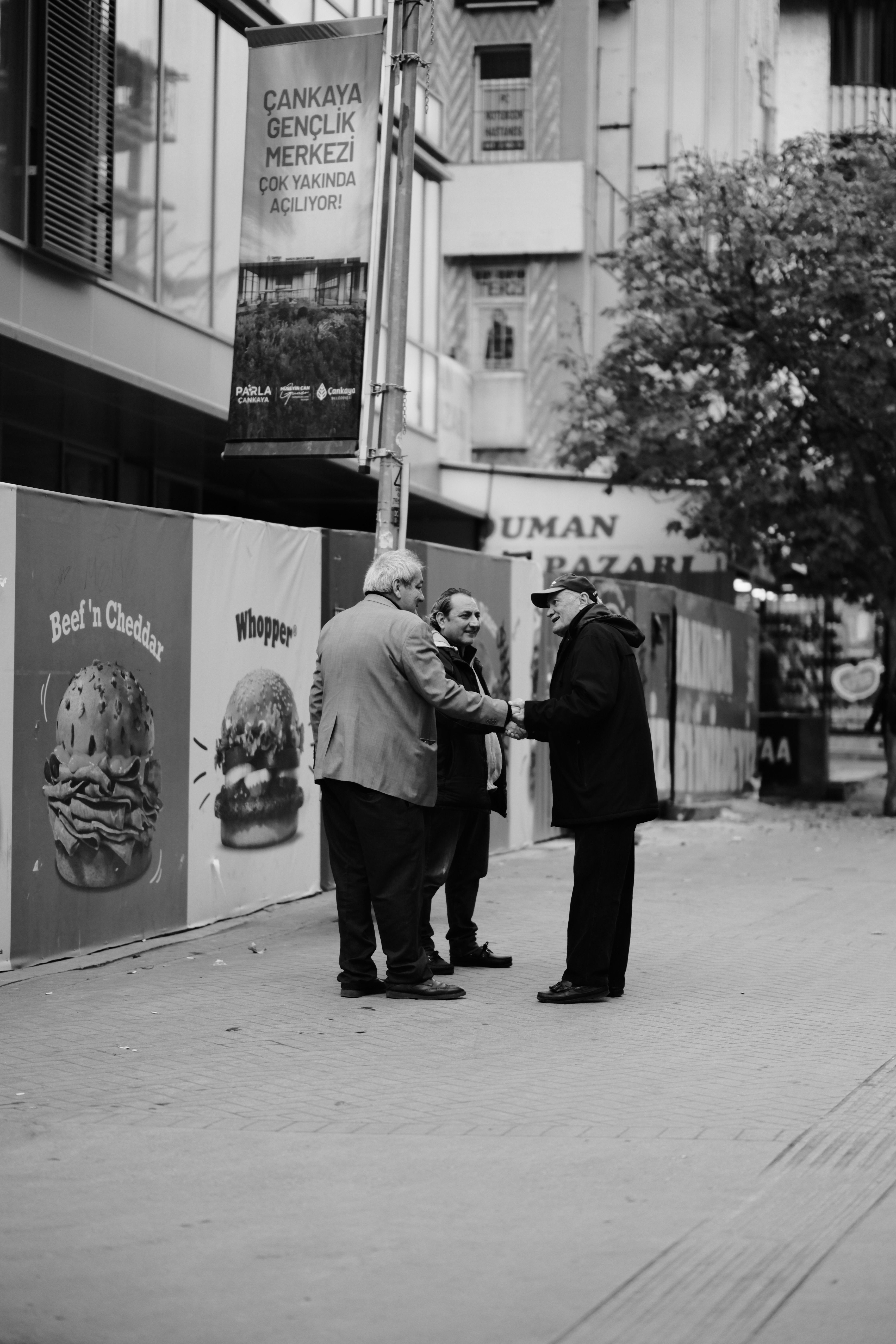 Black and White Urban Street Scene with Three Men · Free Stock Photo