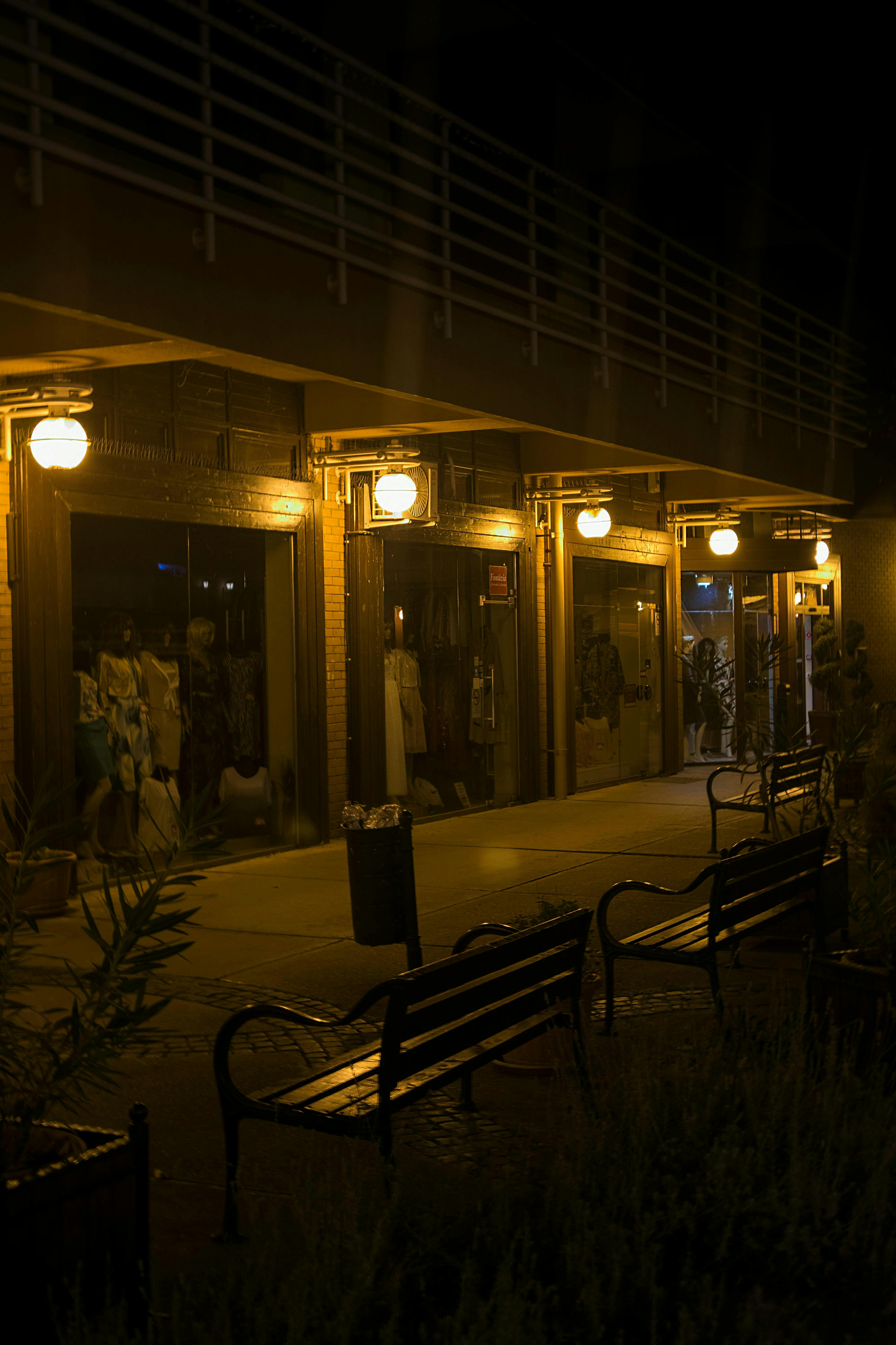 Outdoor Shopping Arcade at Night with Benches · Free Stock Photo