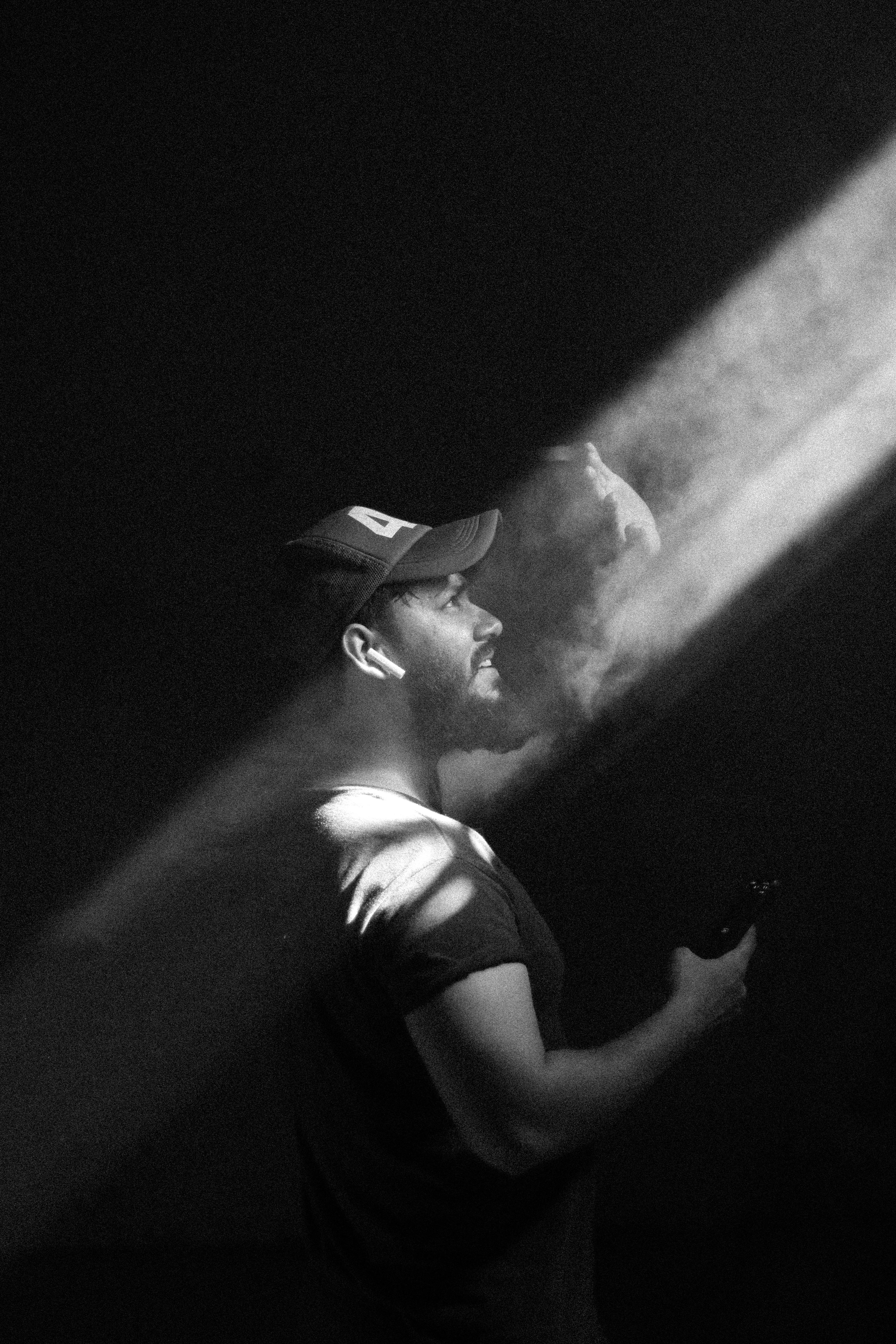 Man in spotlight with dramatic lighting · Free Stock Photo