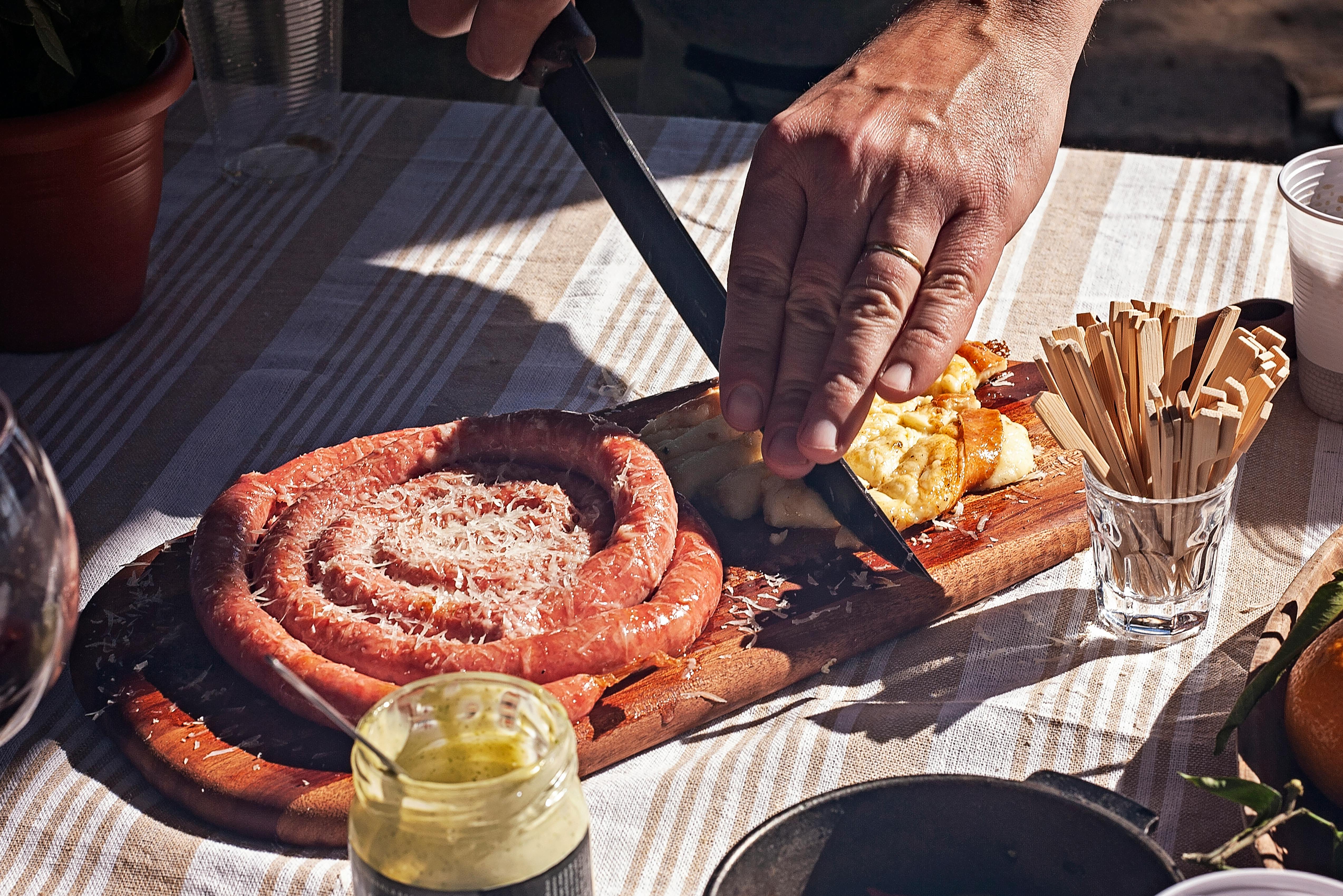 Close-up of Outdoor Barbecue Sausage Preparation · Free Stock Photo