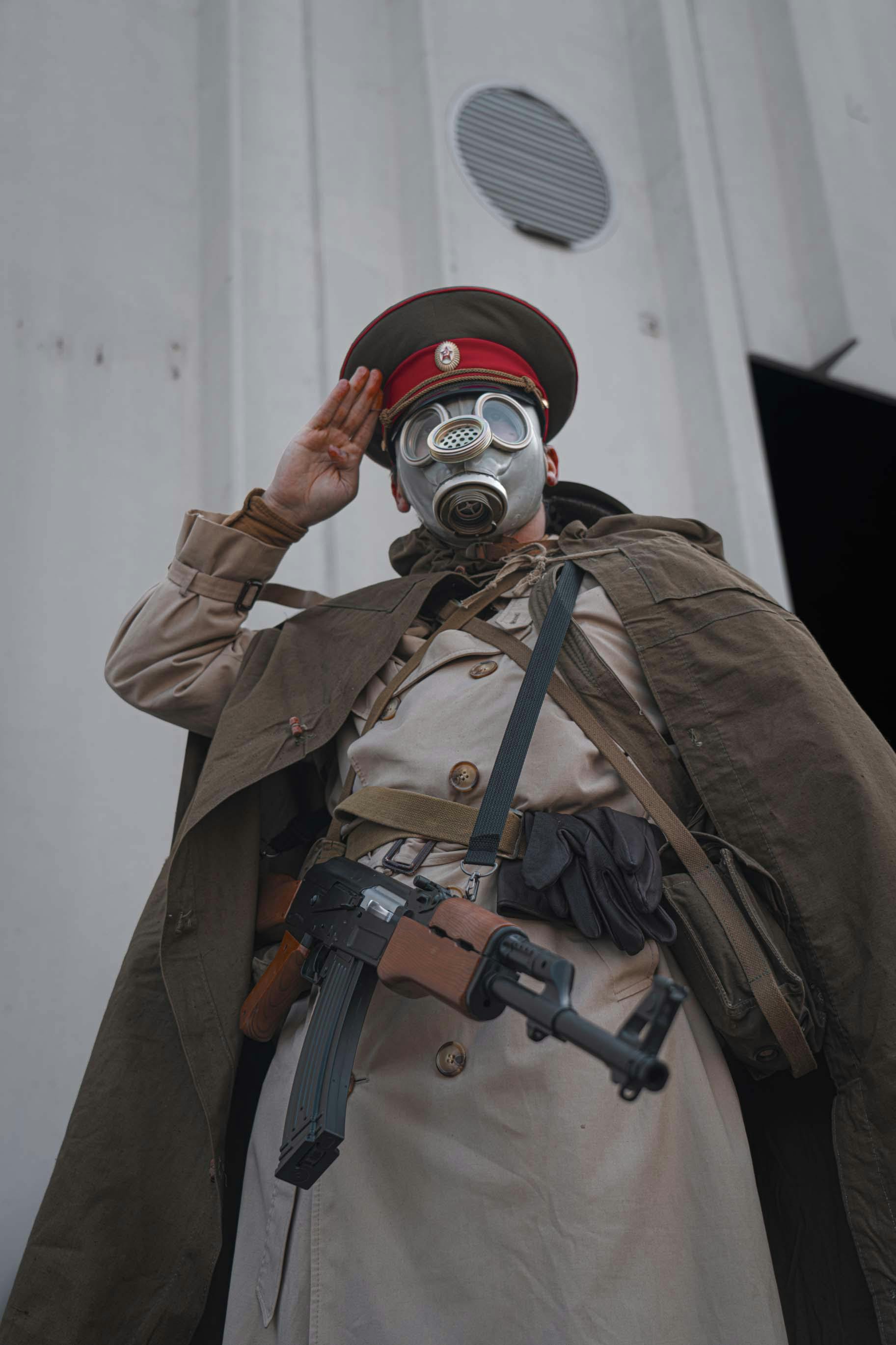 Soviet-Themed Cosplay with Gas Mask and Rifle · Free Stock Photo
