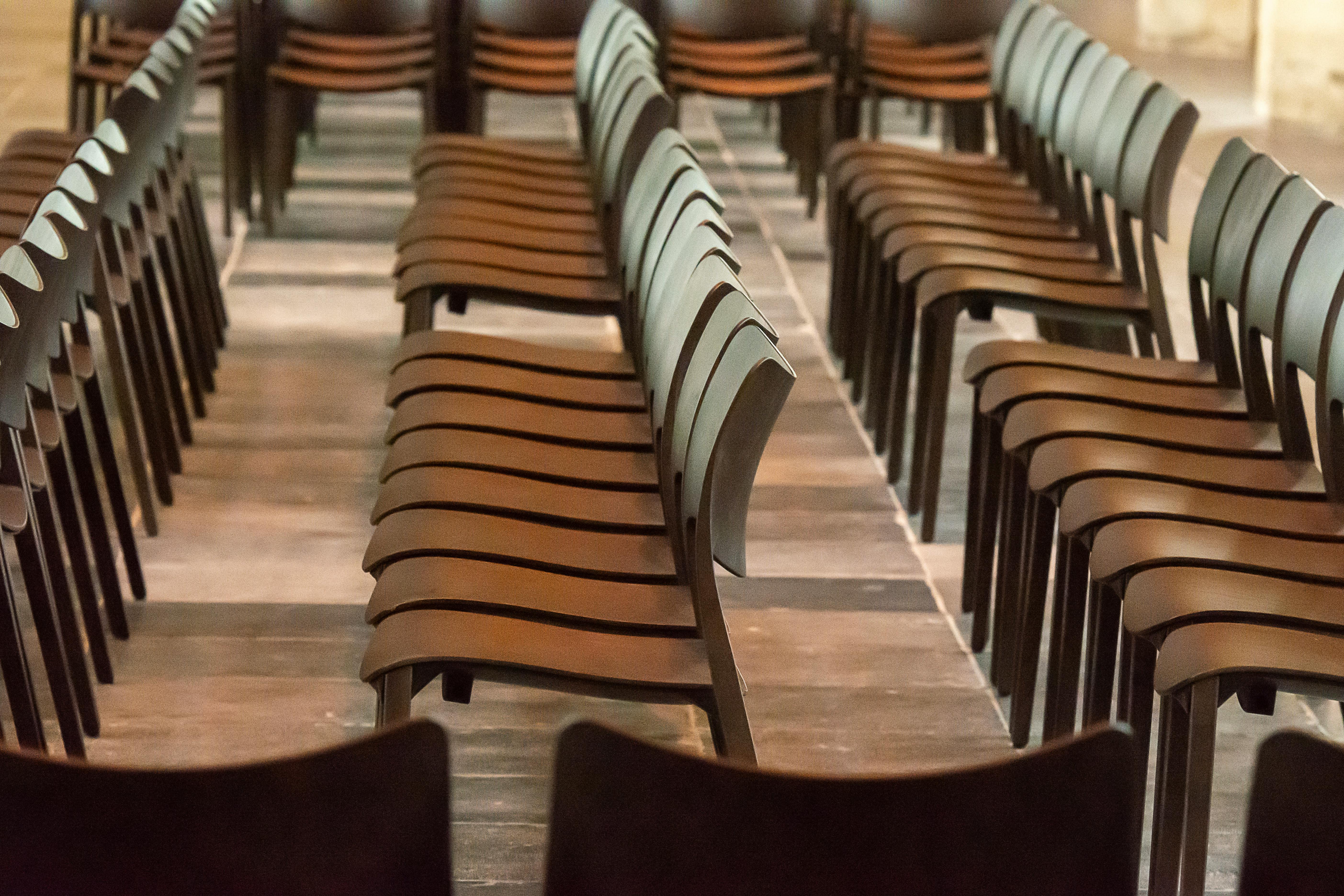 Symmetrical Rows of Wooden Chairs Indoors · Free Stock Photo