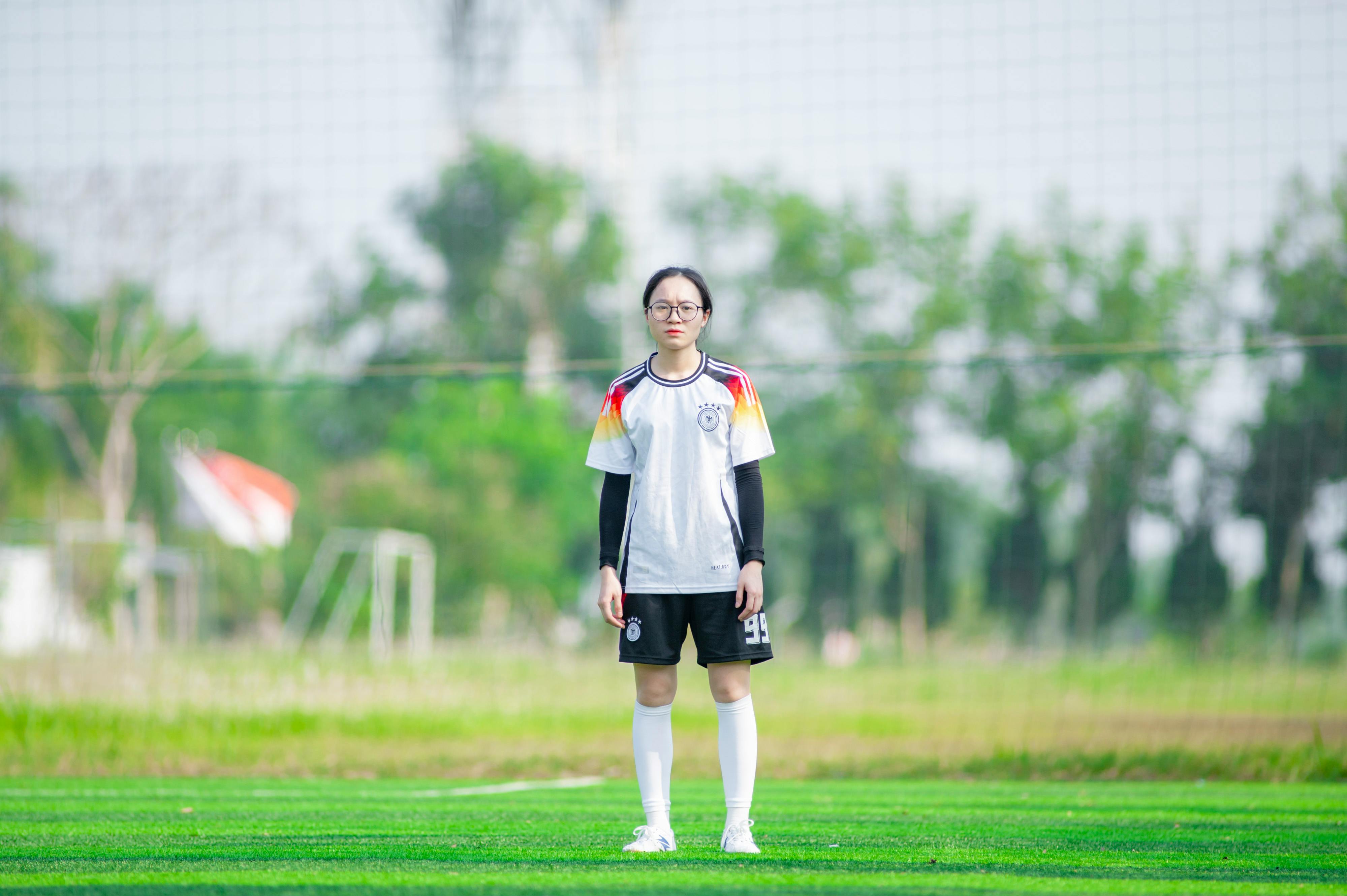 Young Soccer Player Stands on Field in Hà Nội · Free Stock Photo