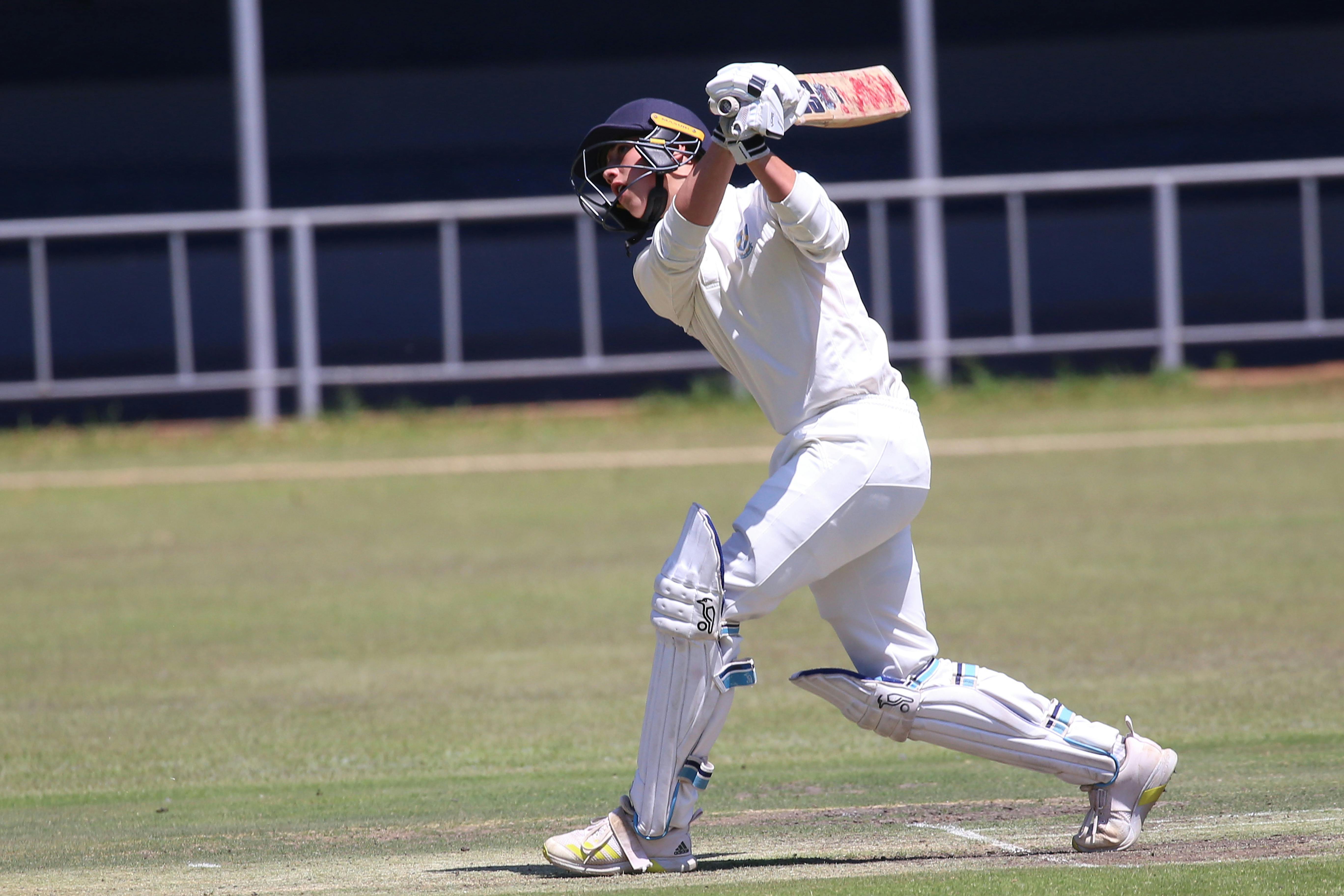 Cricket Batsman Playing Powerful Shot on Field · Free Stock Photo