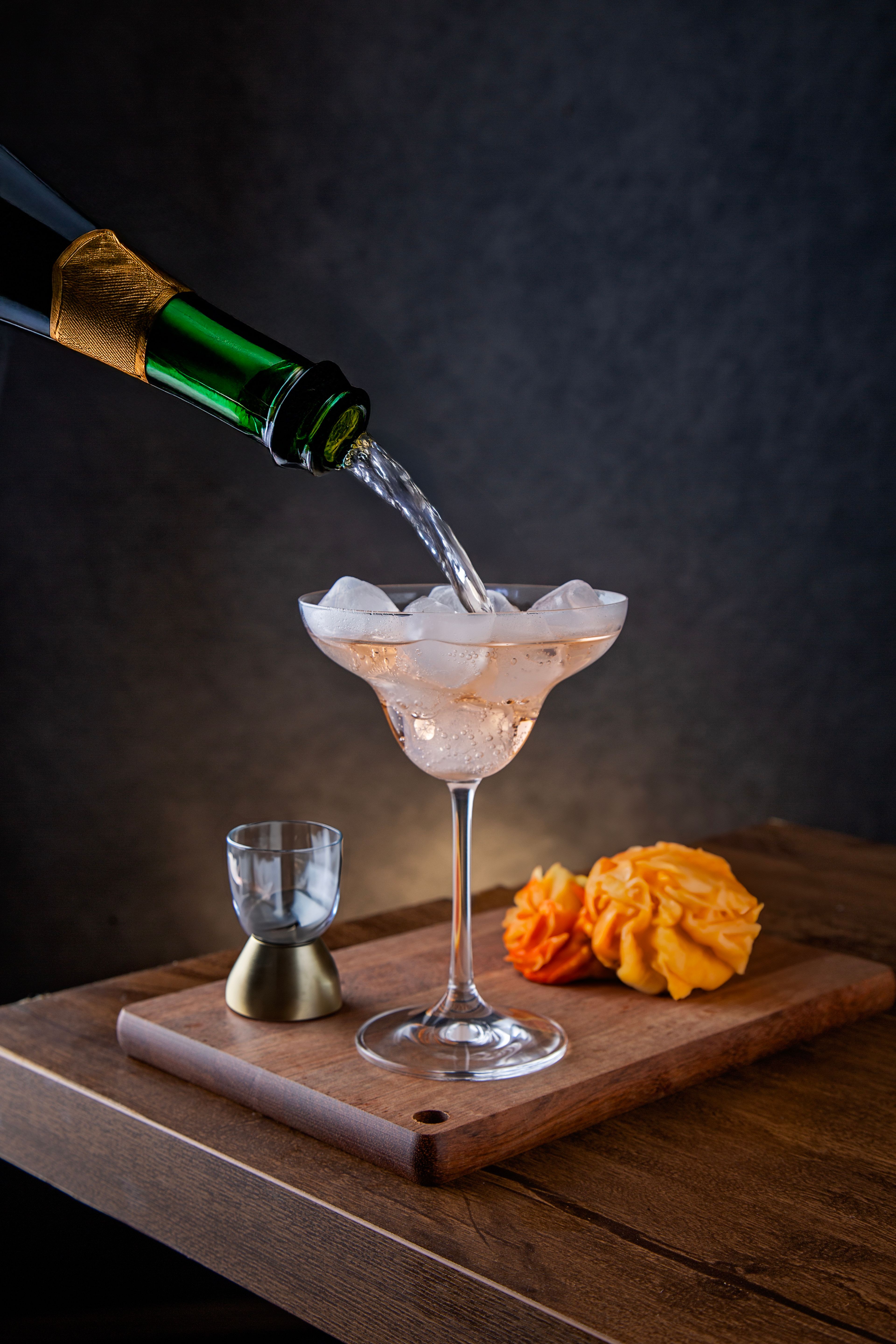 Elegant Cocktail Pouring with Floral Garnish · Free Stock Photo