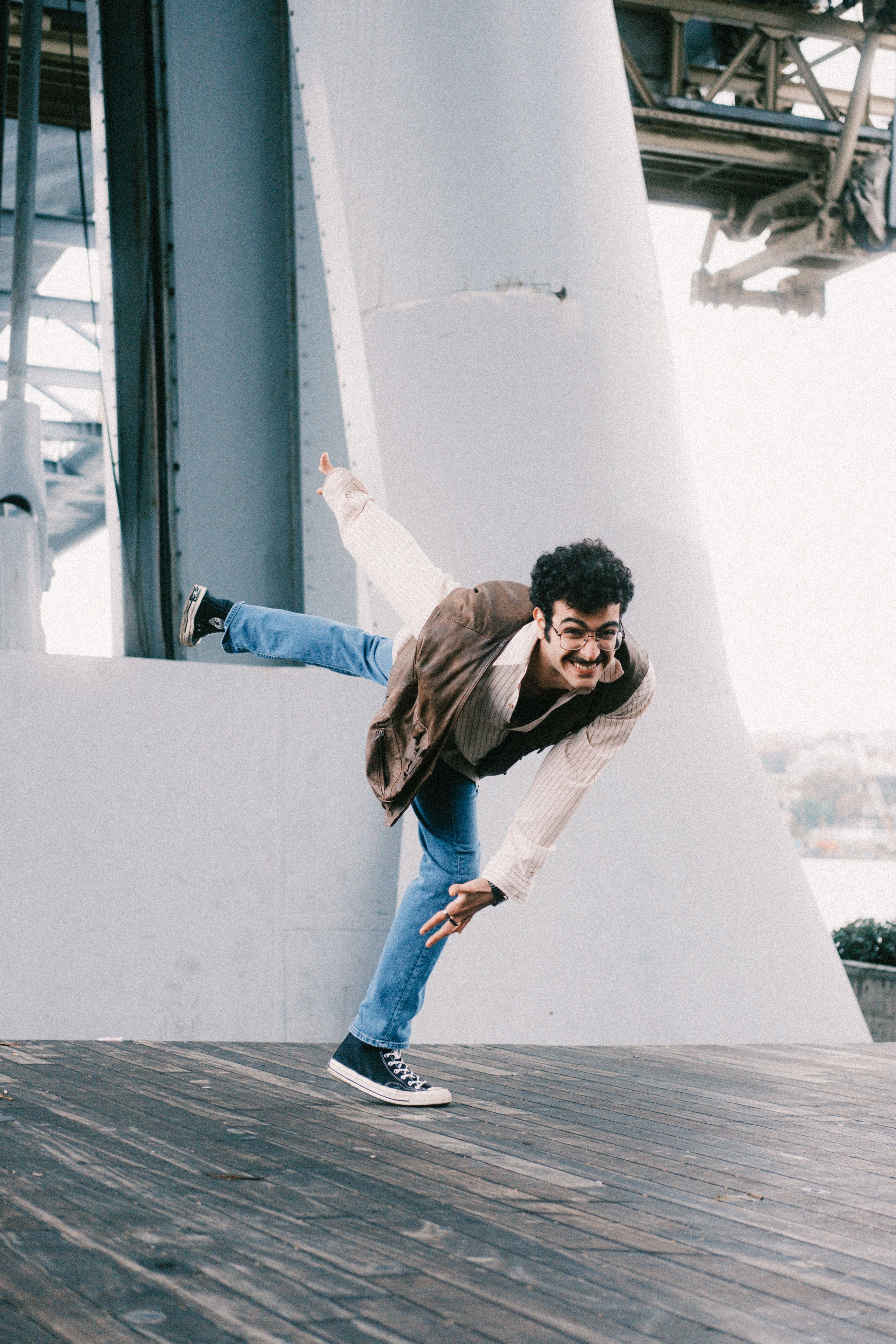 Playful Young Man Posing under Urban Bridge · Free Stock Photo