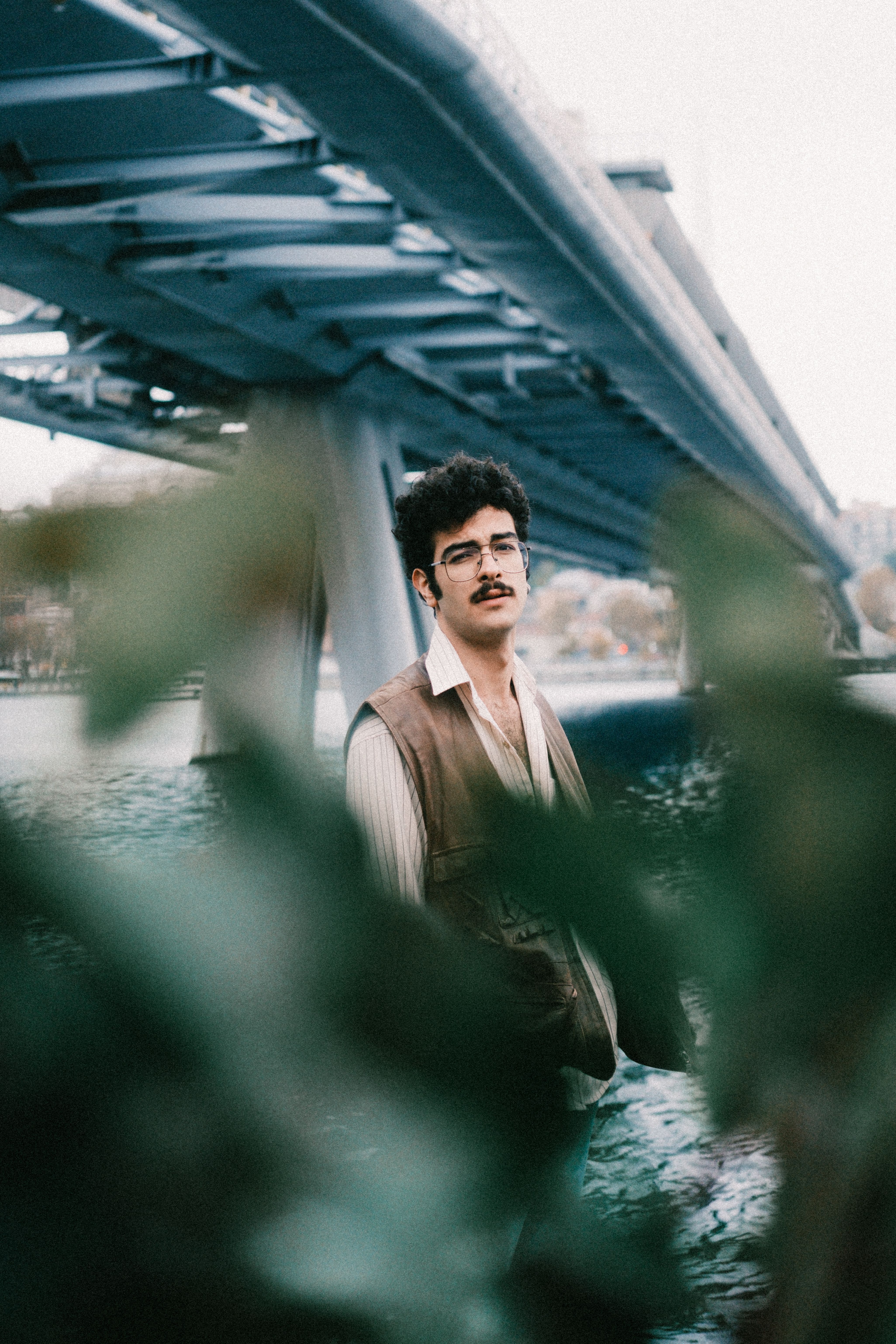 Man Standing Under Bridge by Water · Free Stock Photo