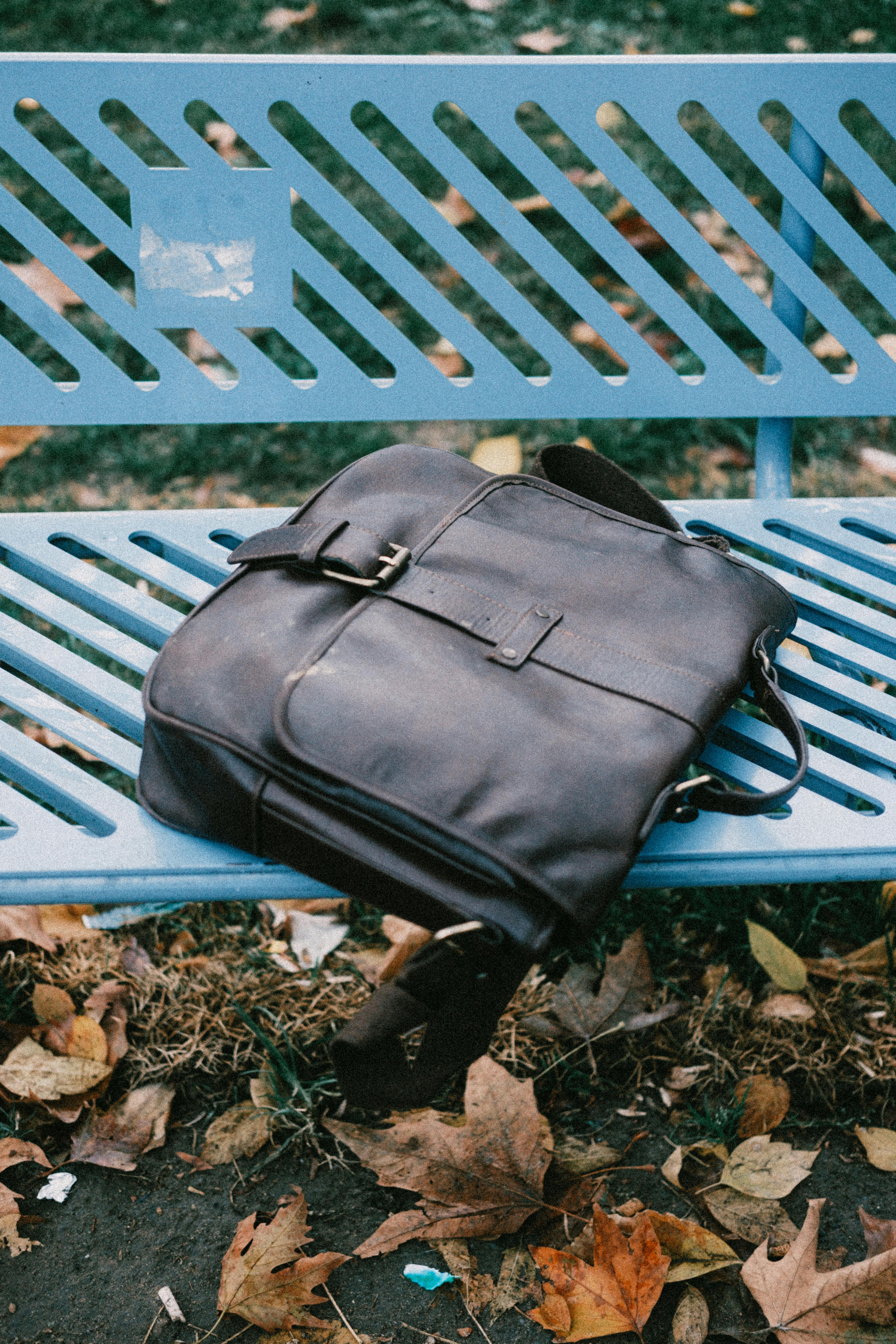 Leather Messenger Bag on Park Bench in Autumn · Free Stock Photo