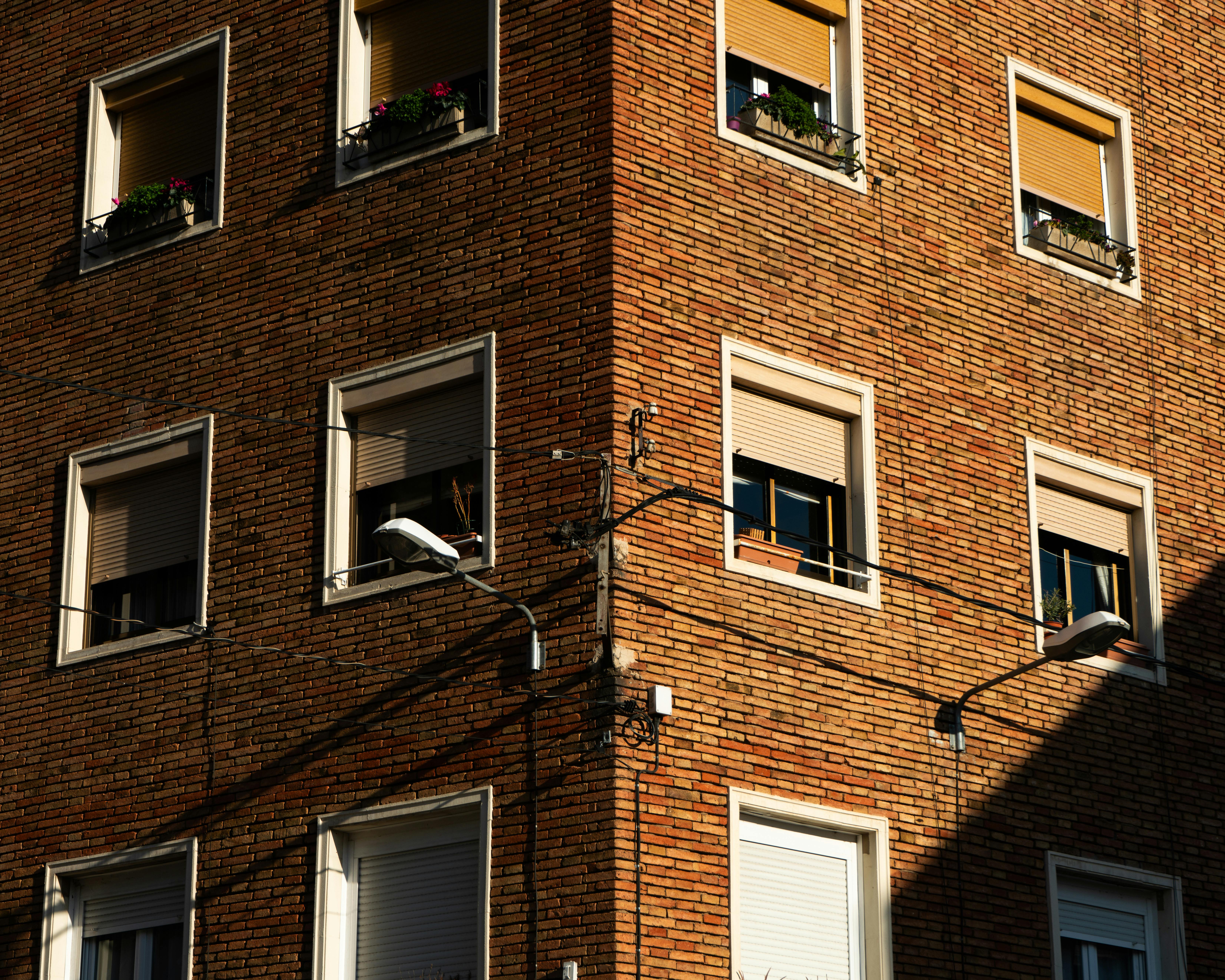 Red Brick Building Corner with Shadows · Free Stock Photo