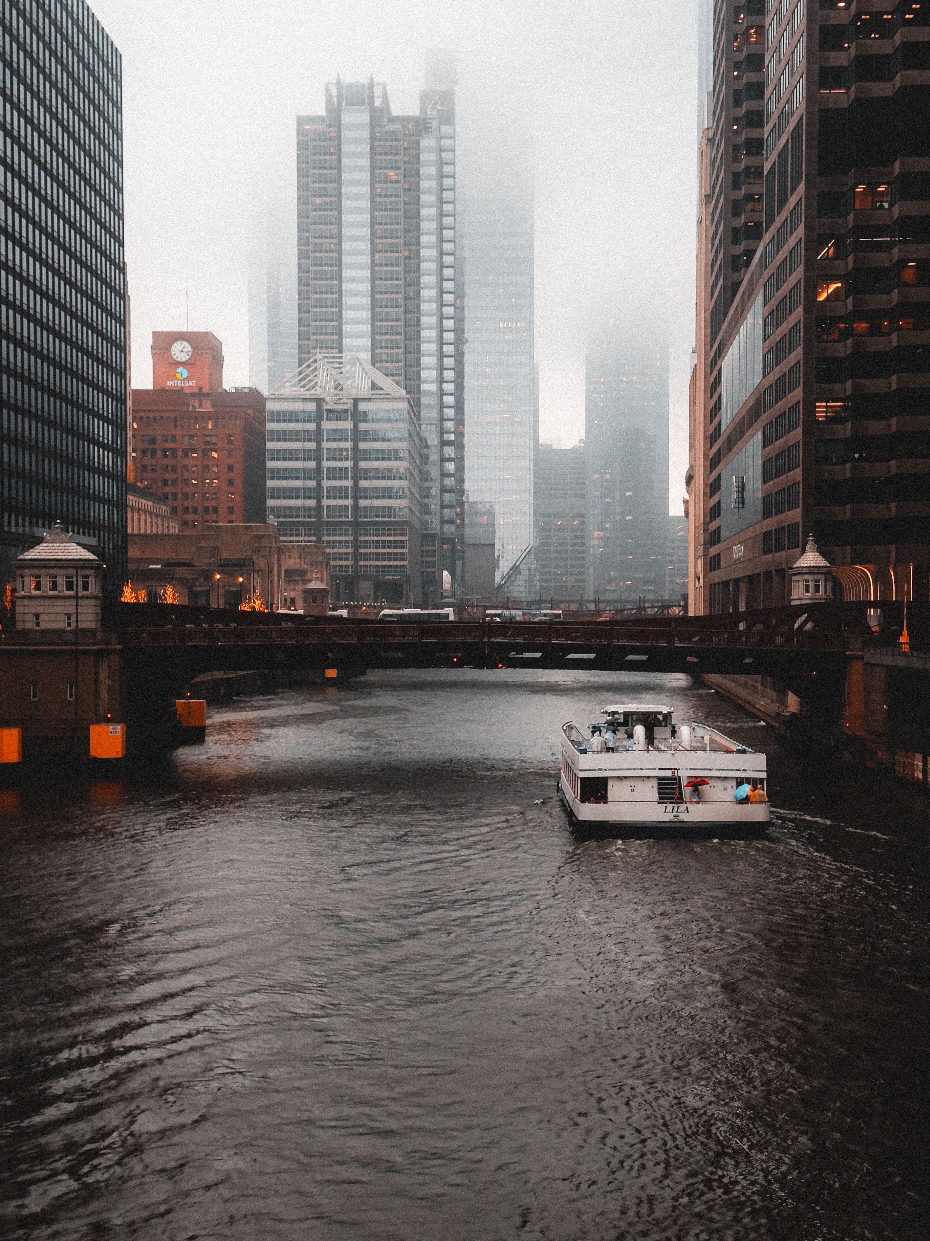 Boat on Body of Water Near Buildings of the City · Free Stock Photo