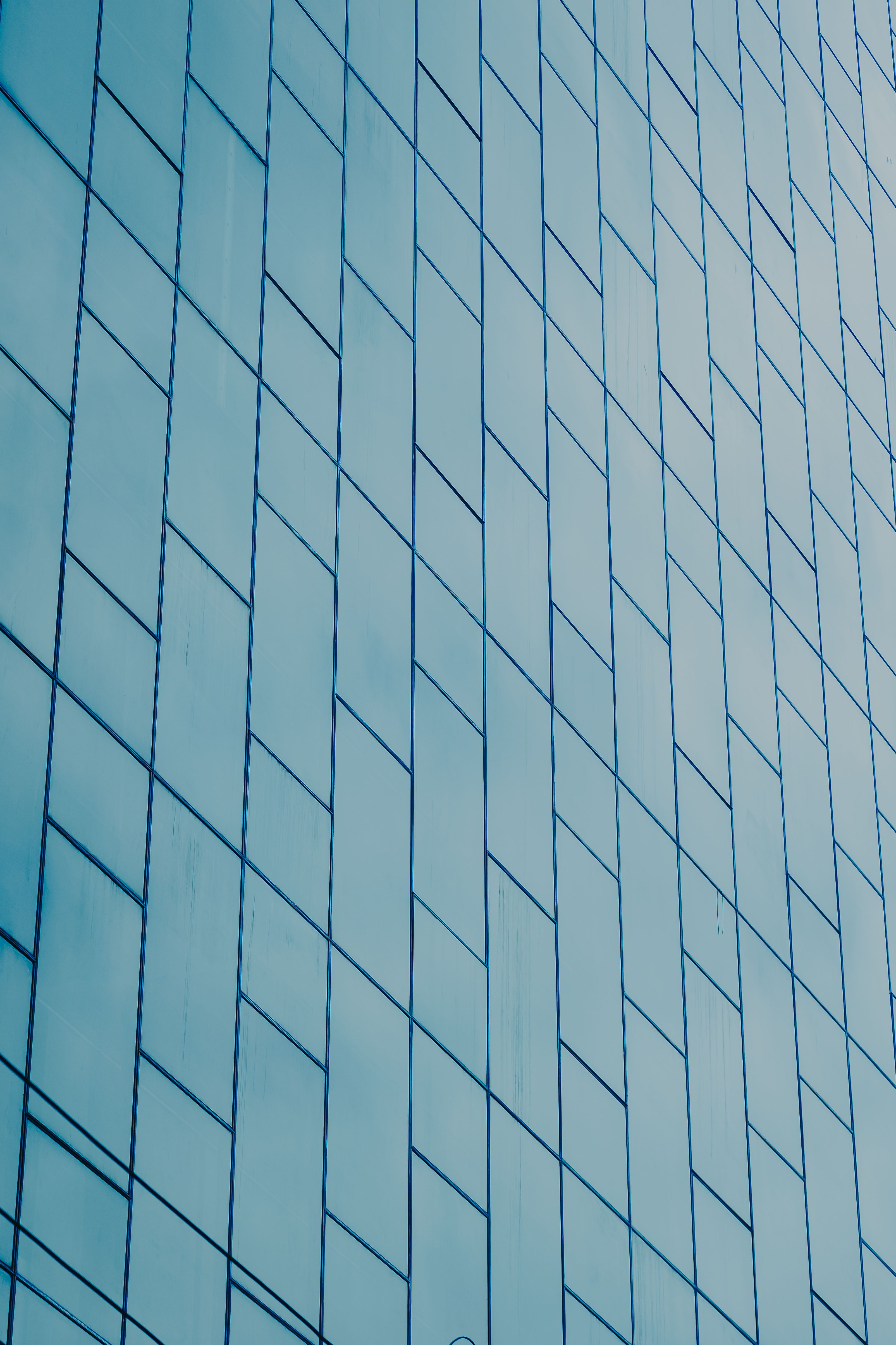 Modern Glass Building Facade with Geometric Pattern · Free Stock Photo