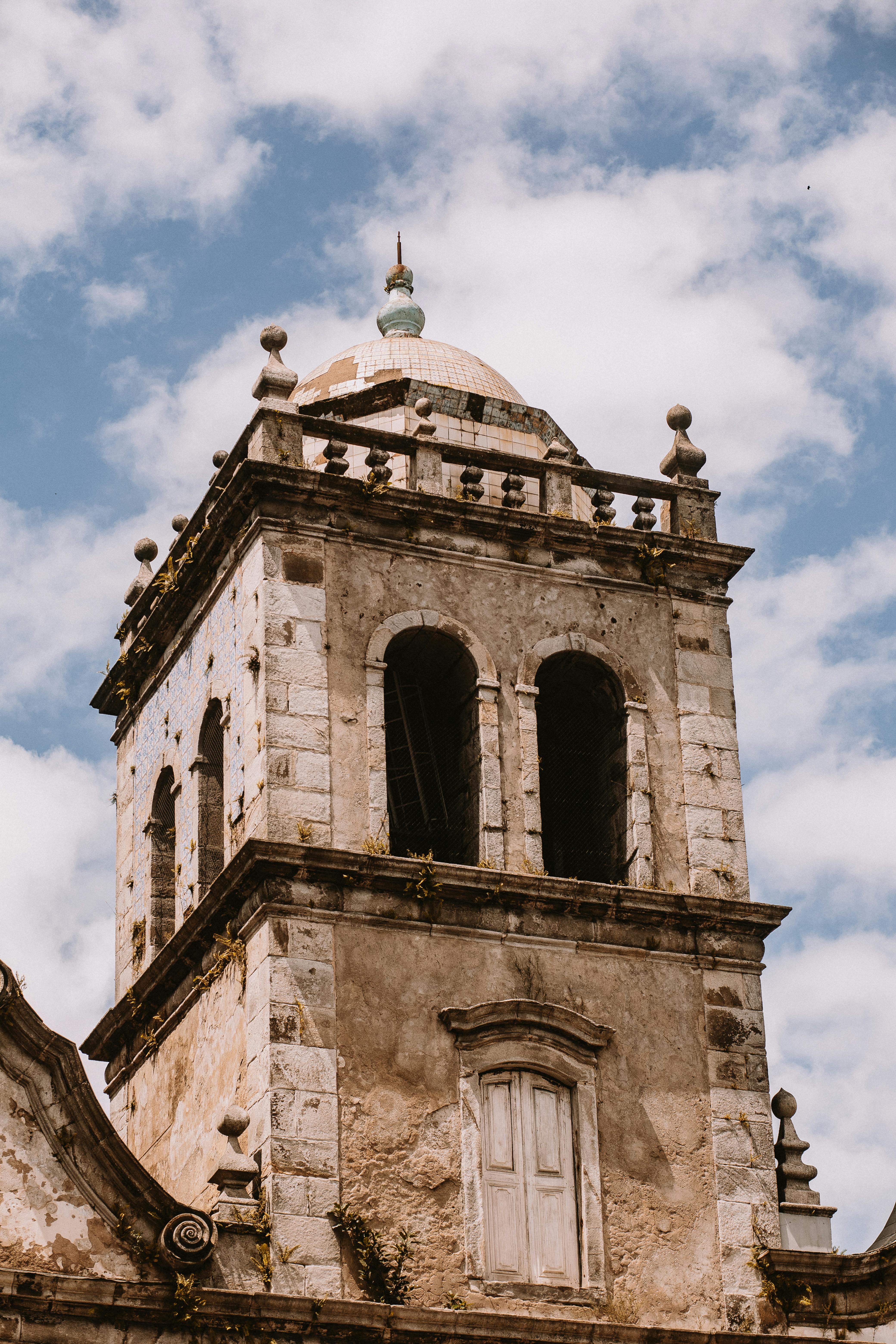 Historic Stone Bell Tower Against Blue Sky · Free Stock Photo