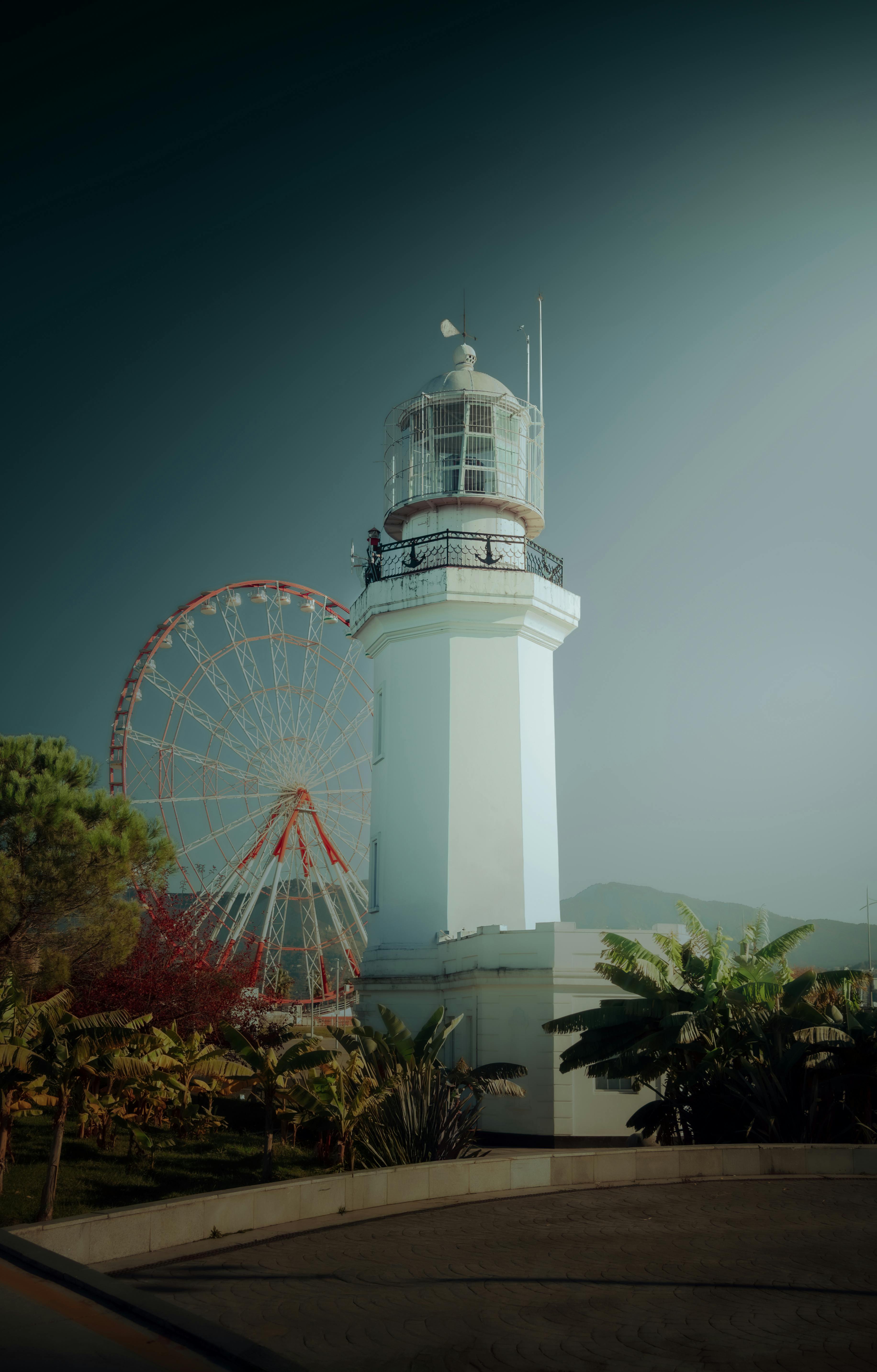 Dramatic Lighthouse and Ferris Wheel in Batumi · Free Stock Photo
