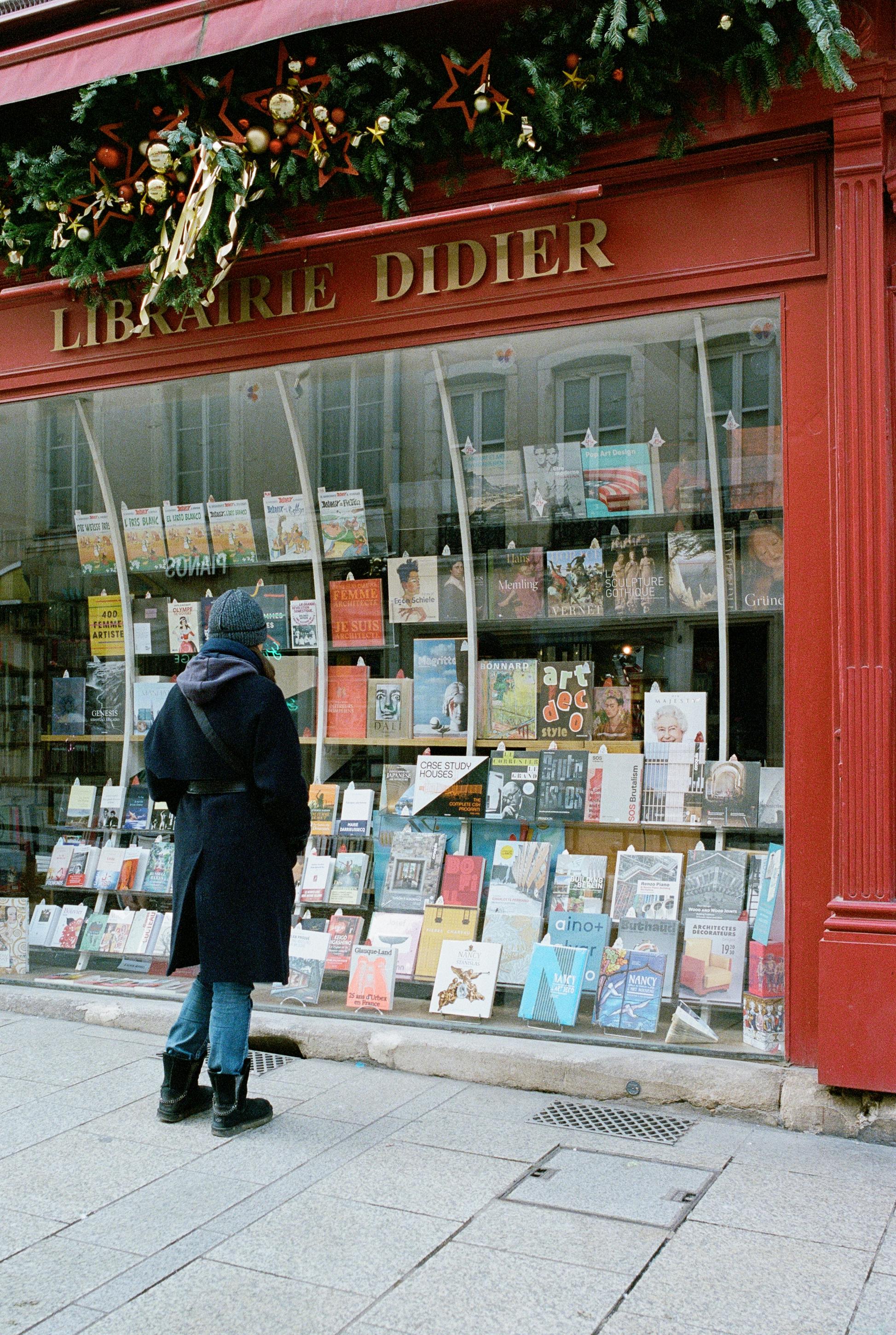 Cliente Disfrutando De Libros Titulados Fuera De Una Librería Francesa ...