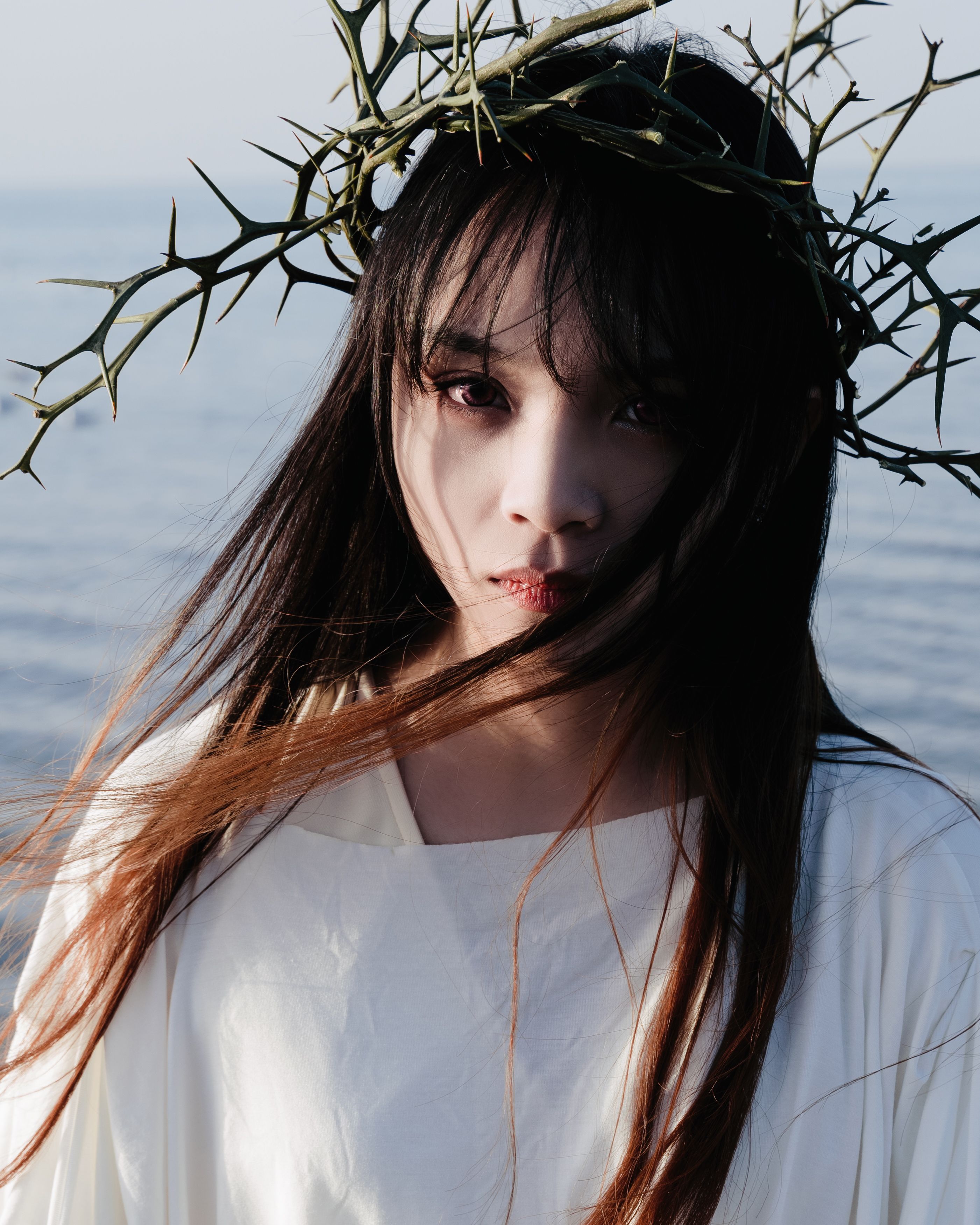 Artistic Portrait of Woman by the Sea with Thorn Crown · Free Stock Photo