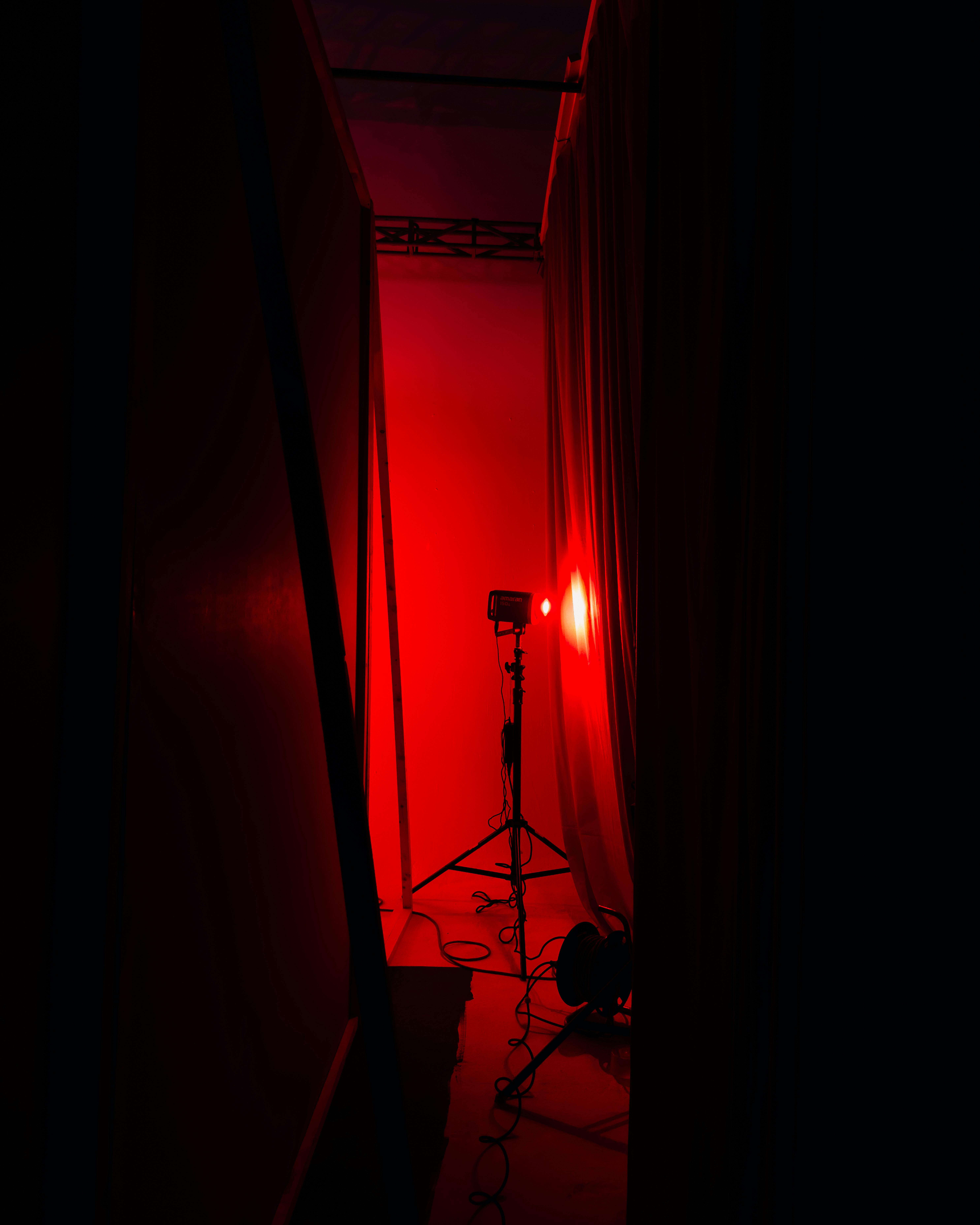 Dramatic Red Lighting Setup in Dark Hallway · Free Stock Photo