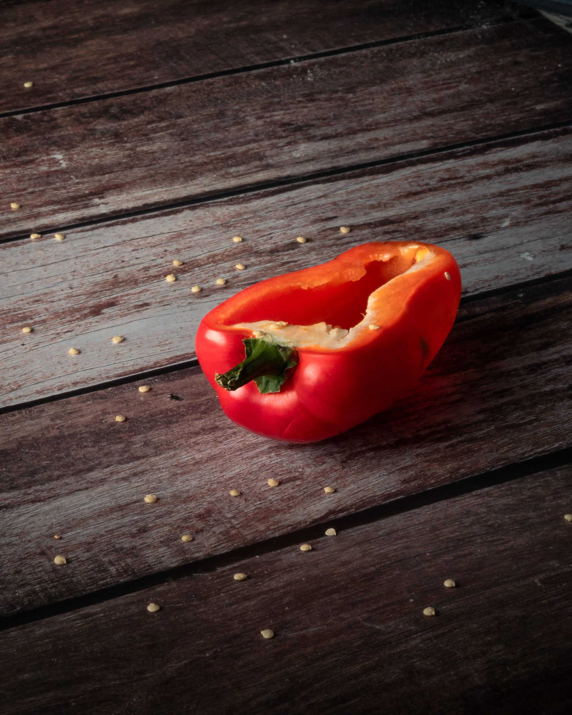 Moody Still Life of Red Bell Pepper on Wood · Free Stock Photo