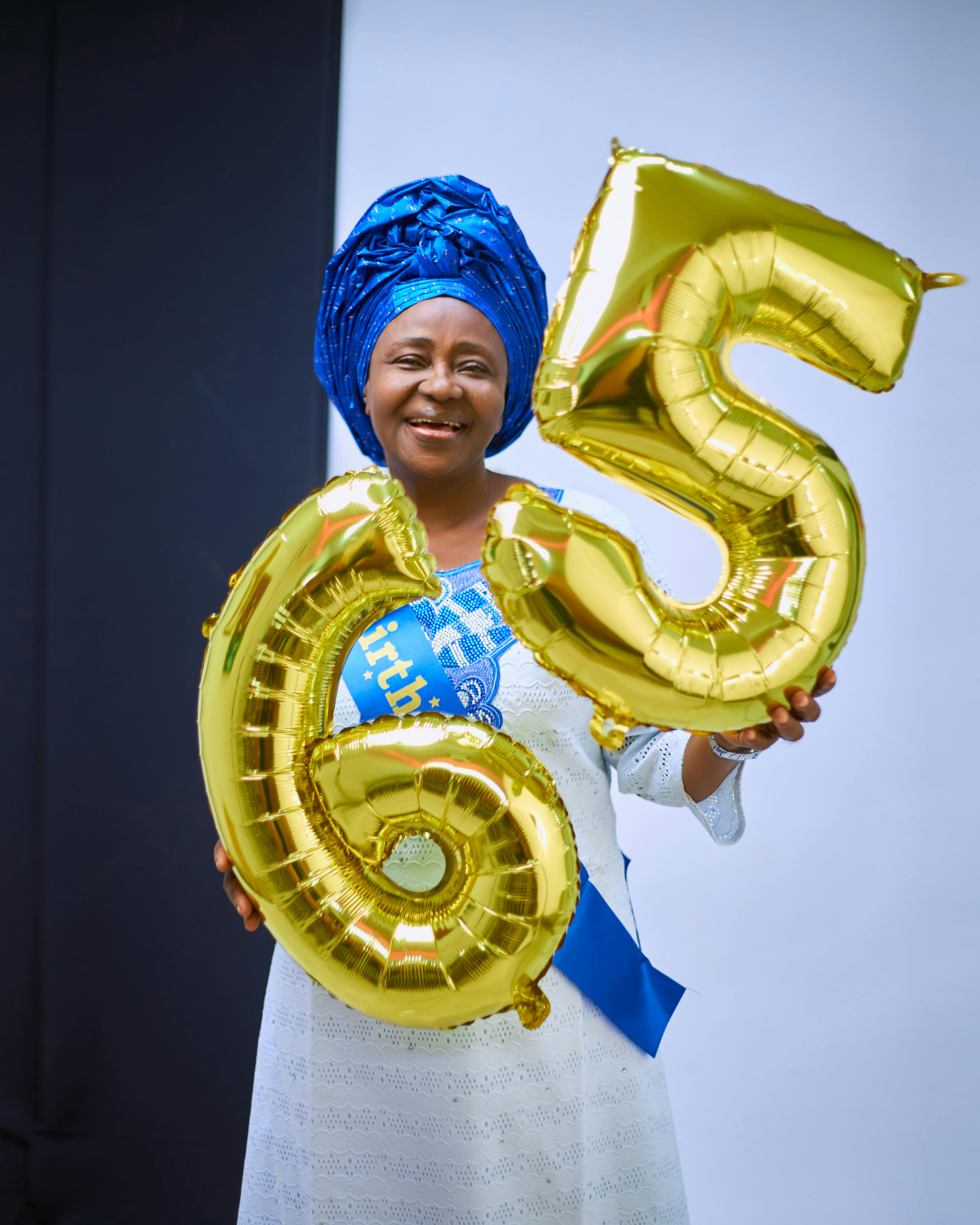 Cheerful Senior Woman Celebrating 65th Birthday · Free Stock Photo