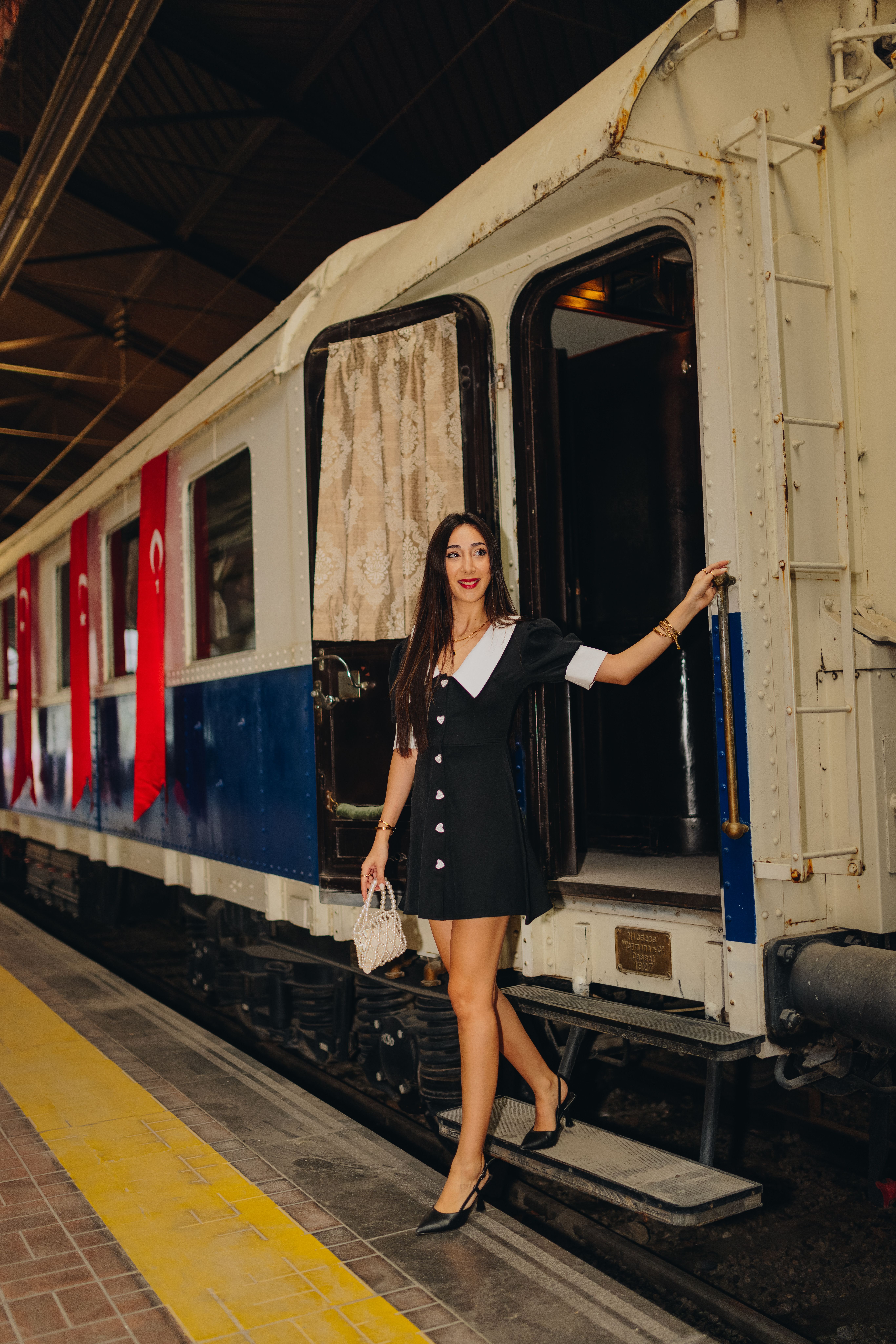 Elegant Woman Posing by Vintage Train at Station · Free Stock Photo