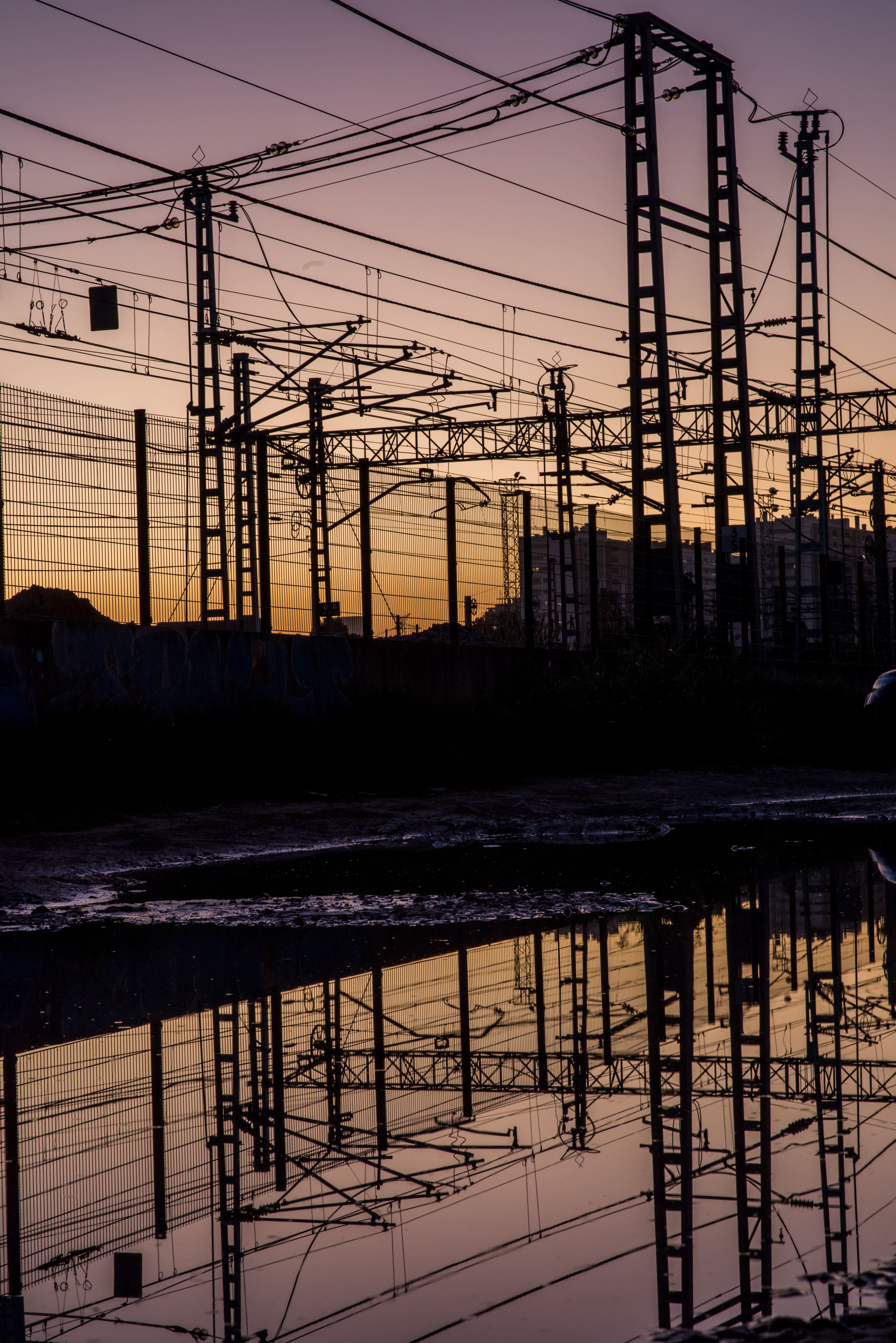 Urban Sunset Reflection on Rail Yard · Free Stock Photo