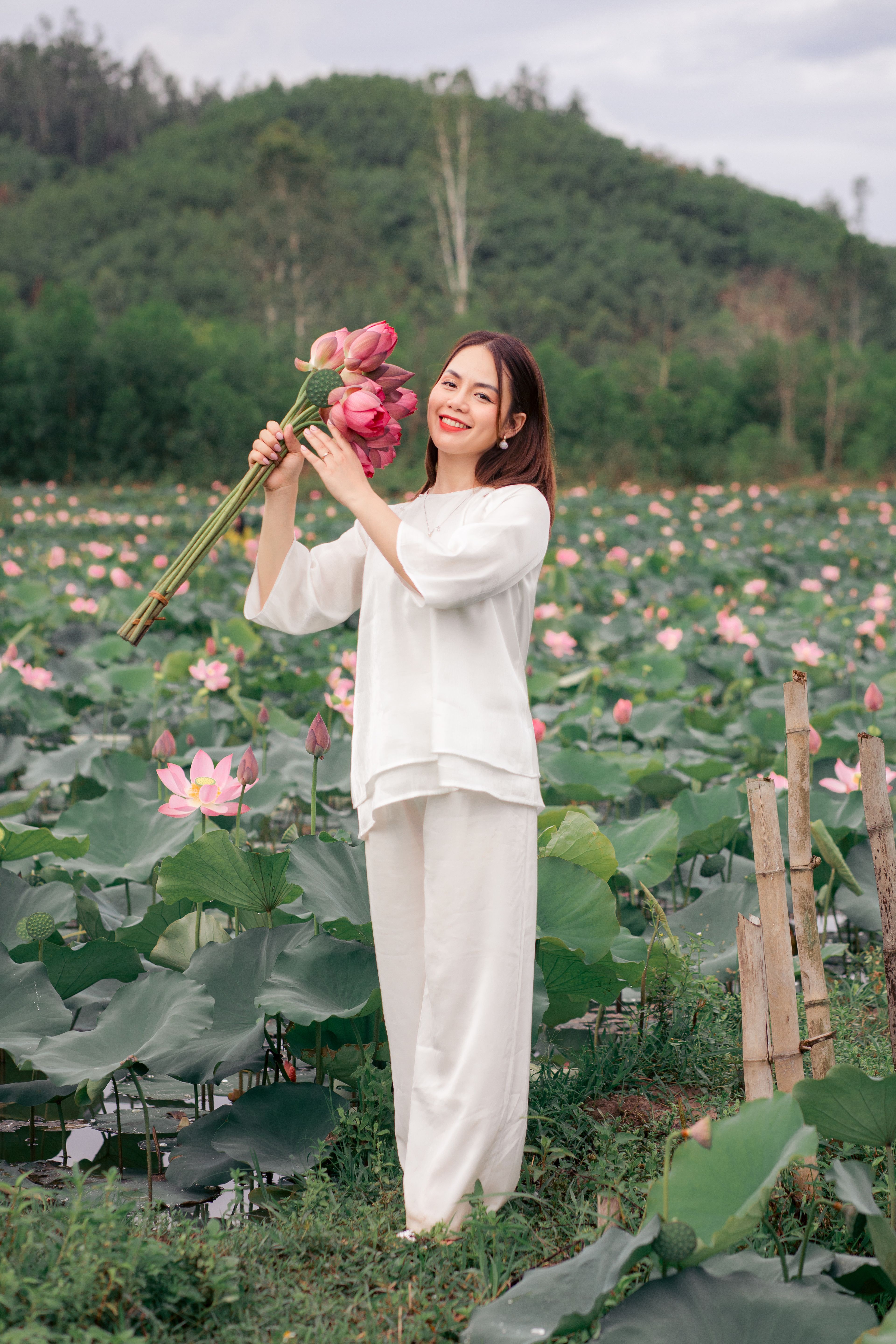 Smiling Woman with Lotus Flowers in Hoi An · Free Stock Photo