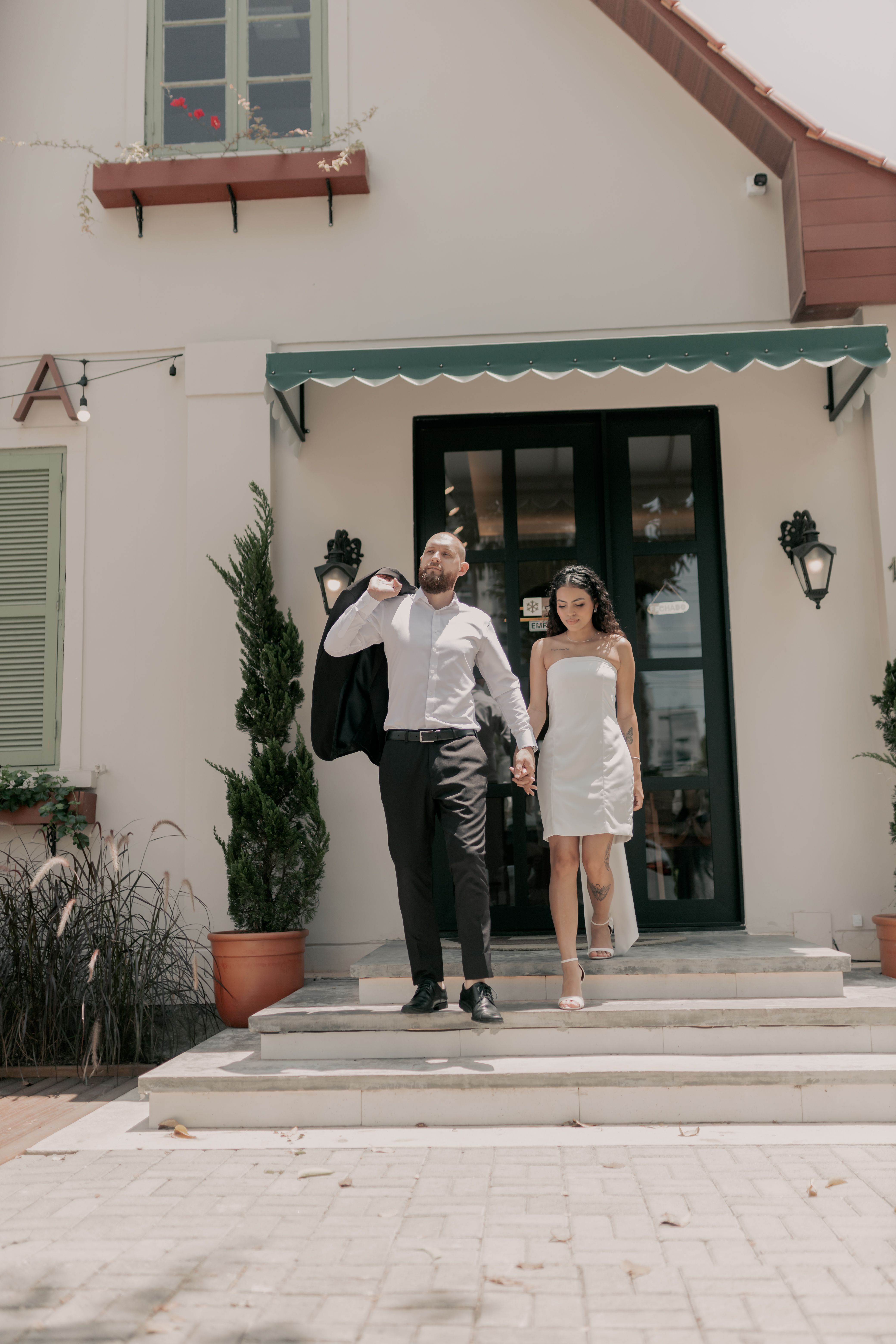 Young Couple Exiting Modern House Together · Free Stock Photo