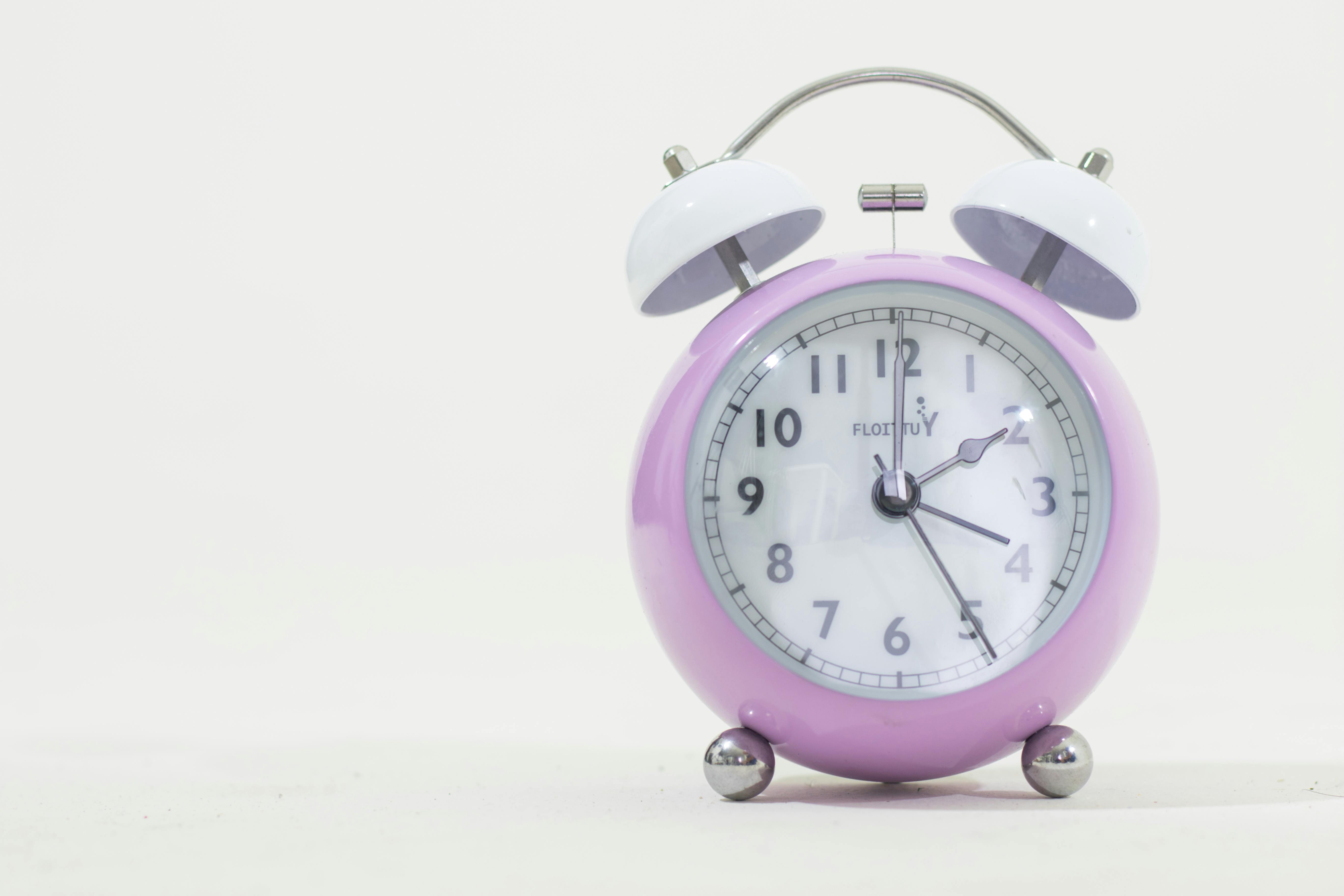 Cute Lilac Alarm Clock on White Background · Free Stock Photo