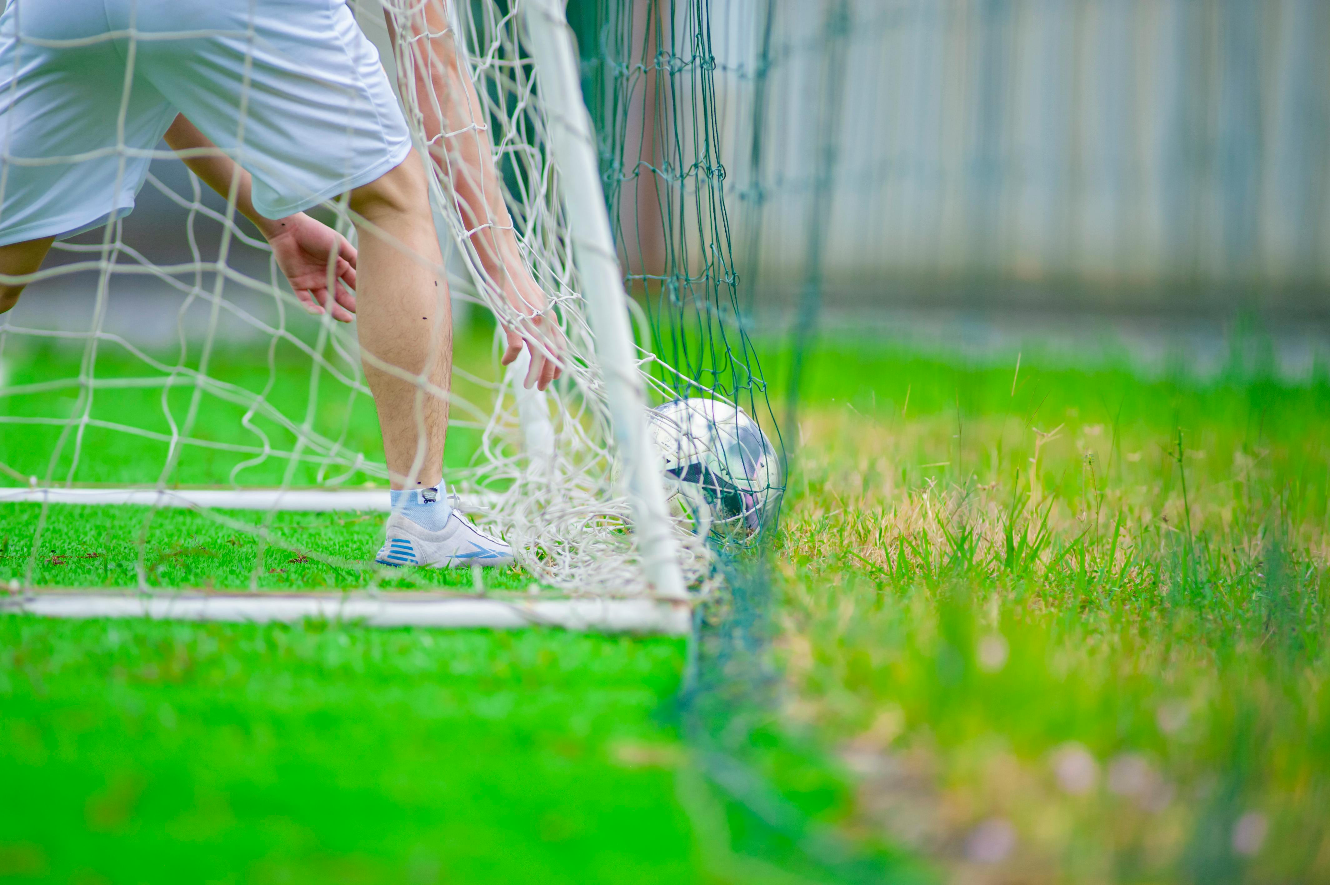 Soccer Player Retrieving Ball from Goal in Hanoi · Free Stock Photo