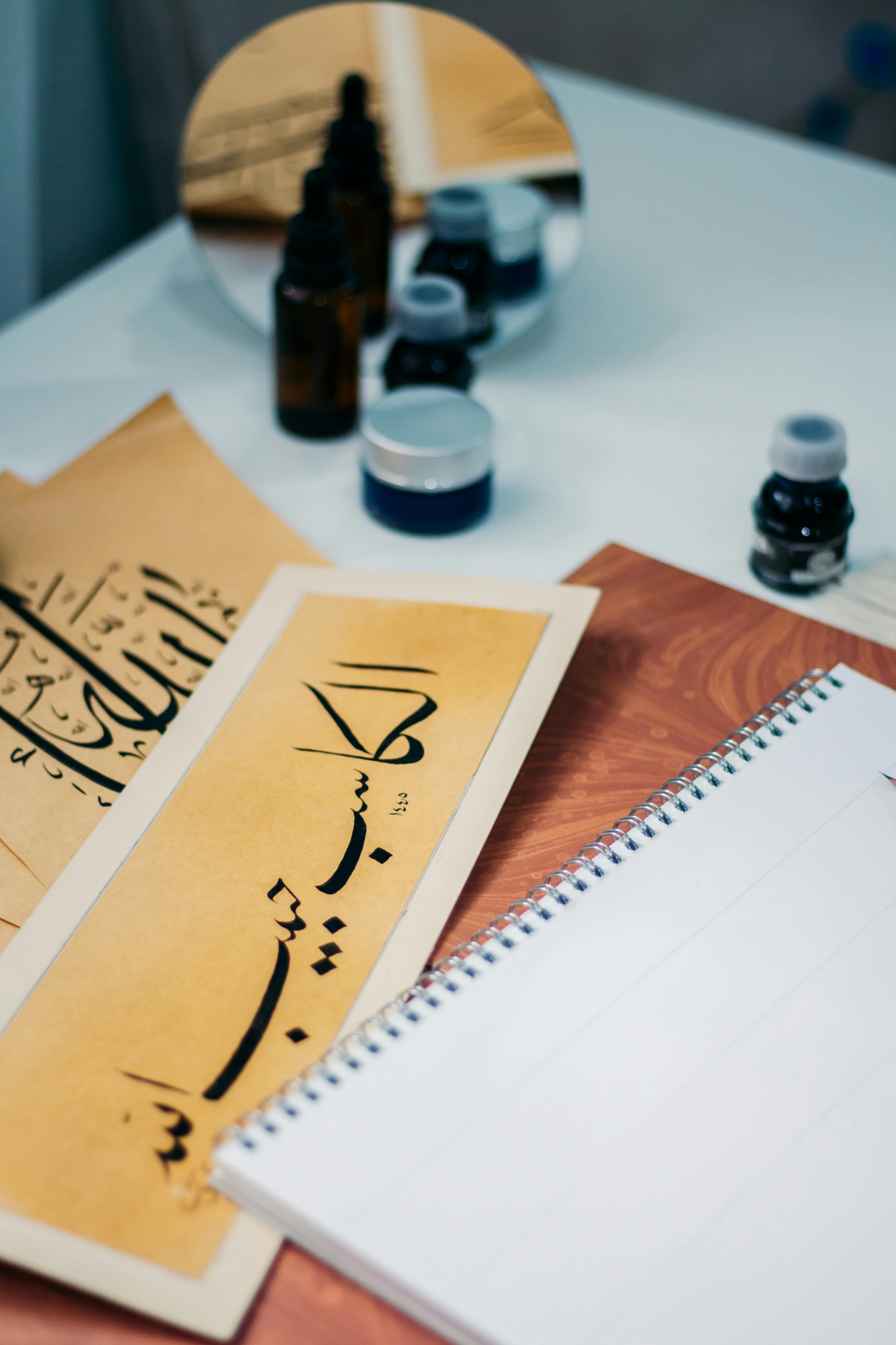 Arabic Calligraphy Art with Ink Bottles · Free Stock Photo