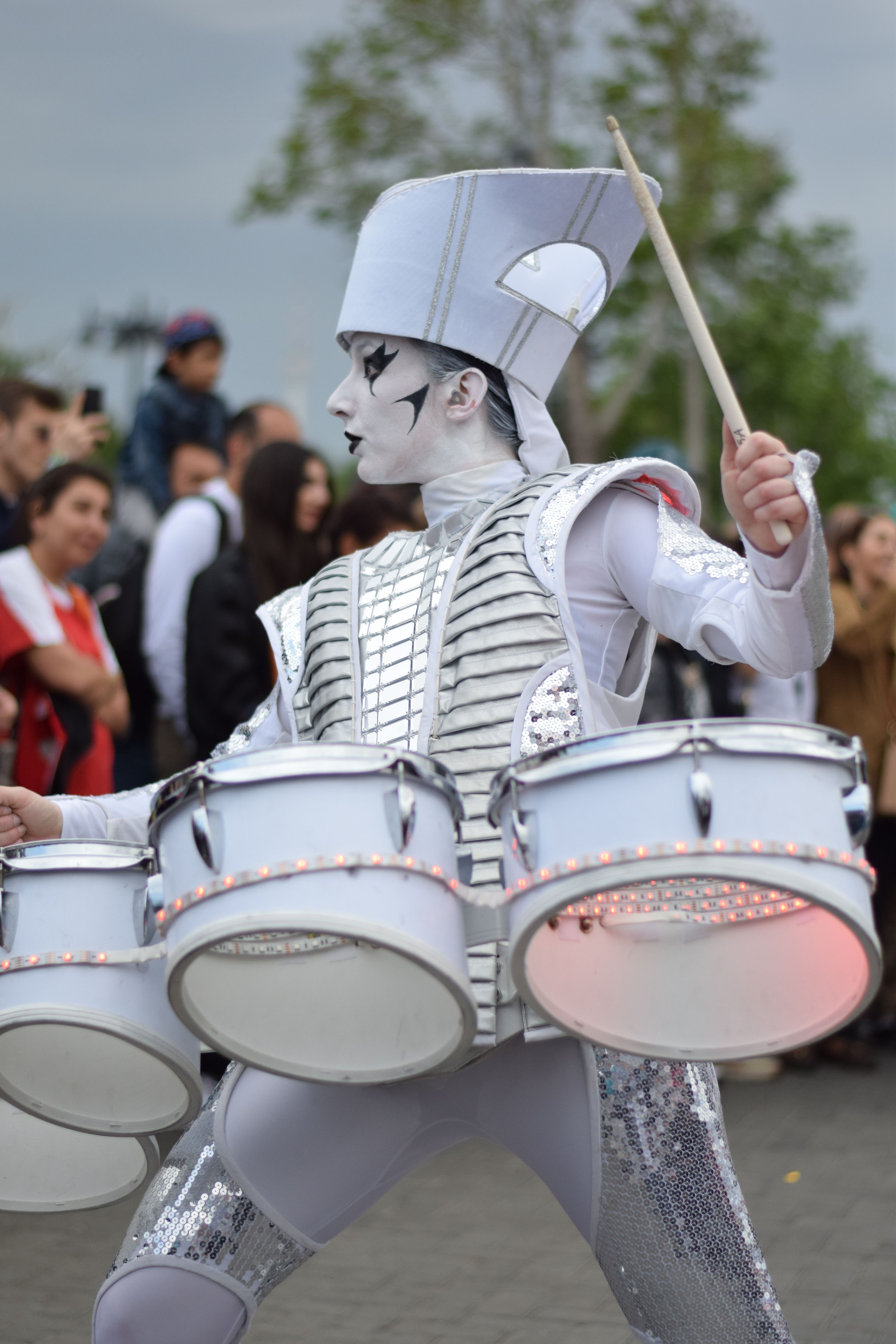 Street Performer Playing Drums in Futuristic Costume · Free Stock Photo