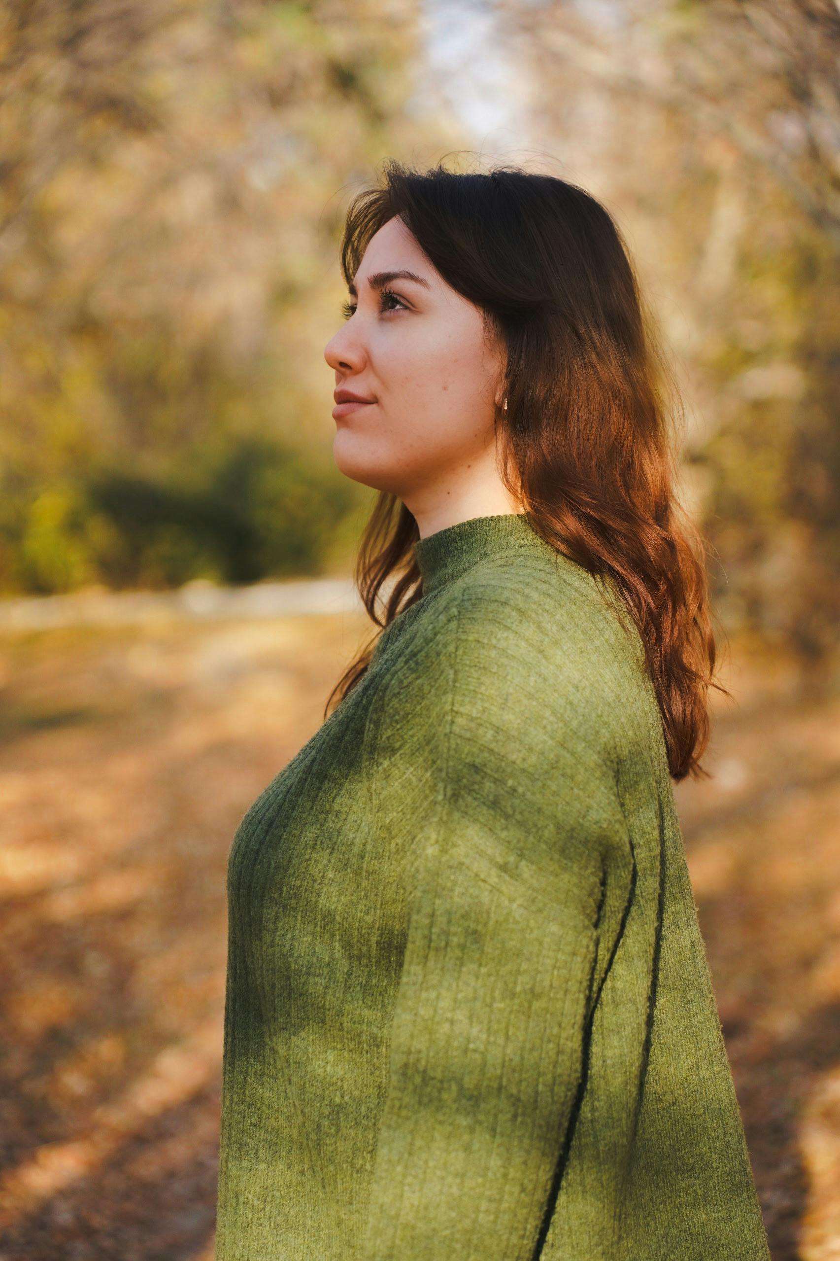 Profile Portrait of Woman in Green Sweater Outdoors · Free Stock Photo
