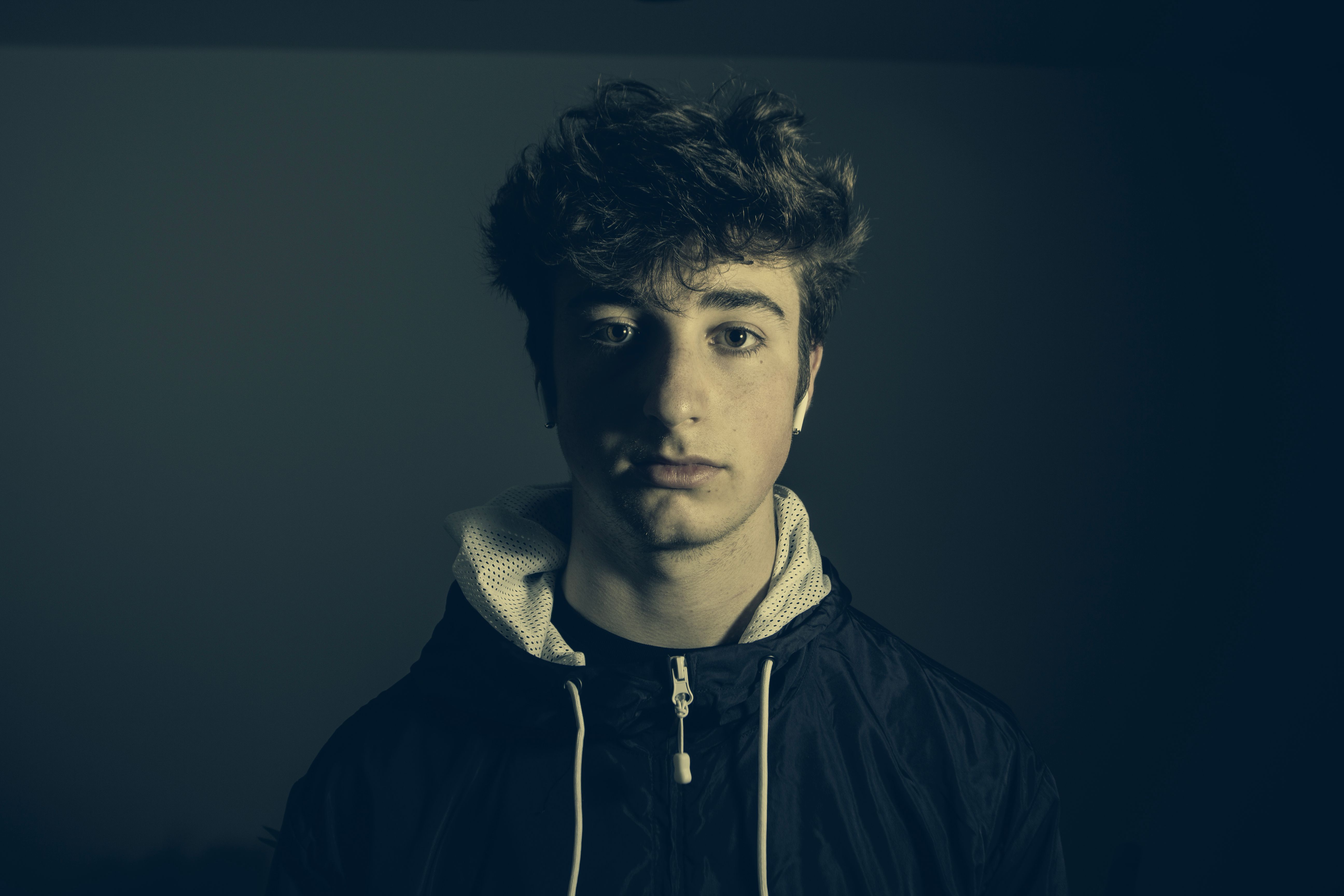 Moody Portrait of a Young Man in Dark Tones · Free Stock Photo