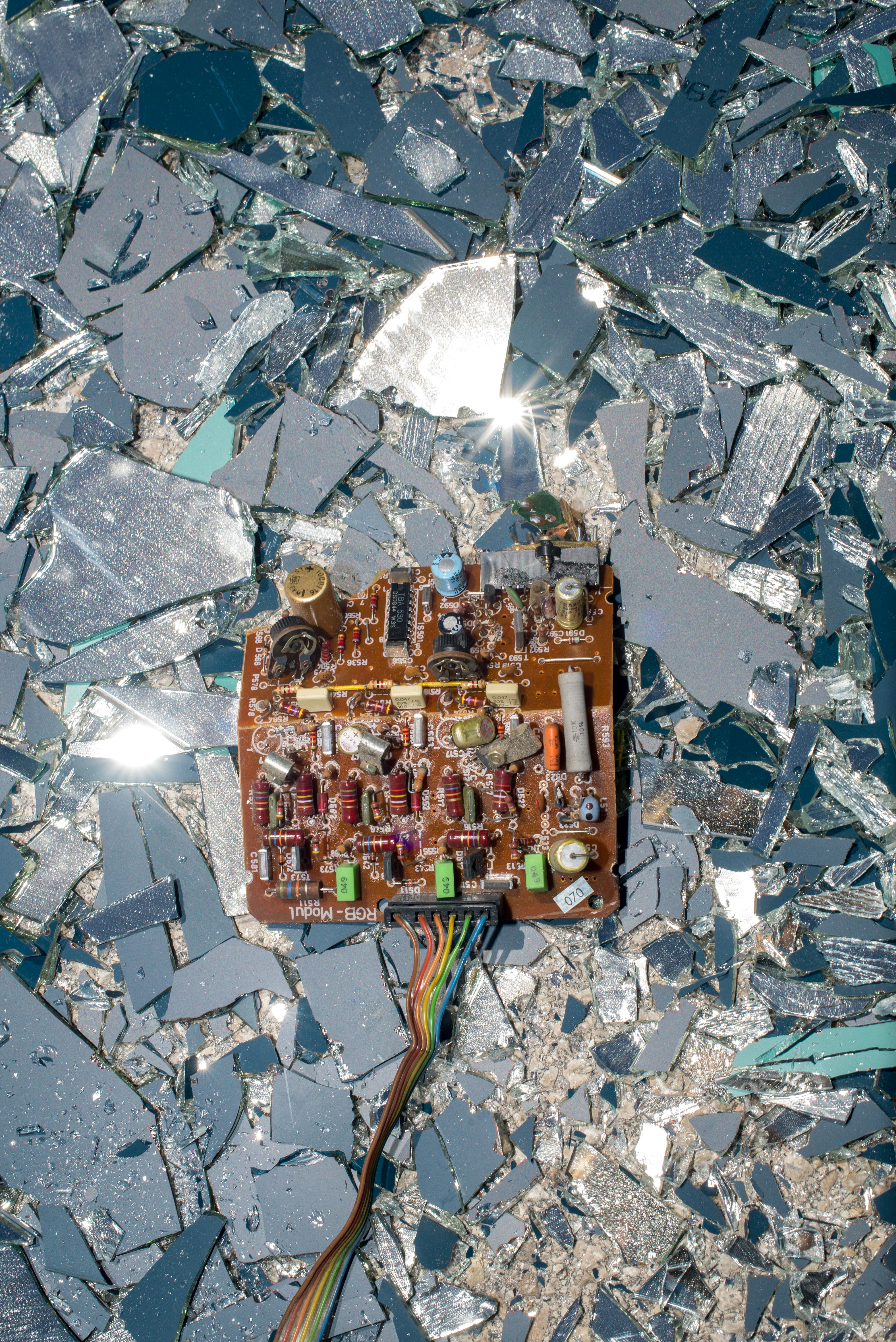 Circuit Board on Shattered Glass Surface · Free Stock Photo